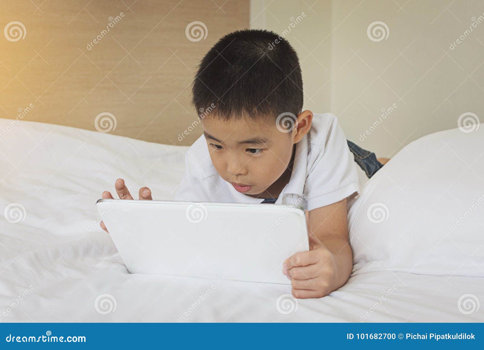 Asian Little Boy Using Tablet Computer in Bed Stock Photo - Image of ...