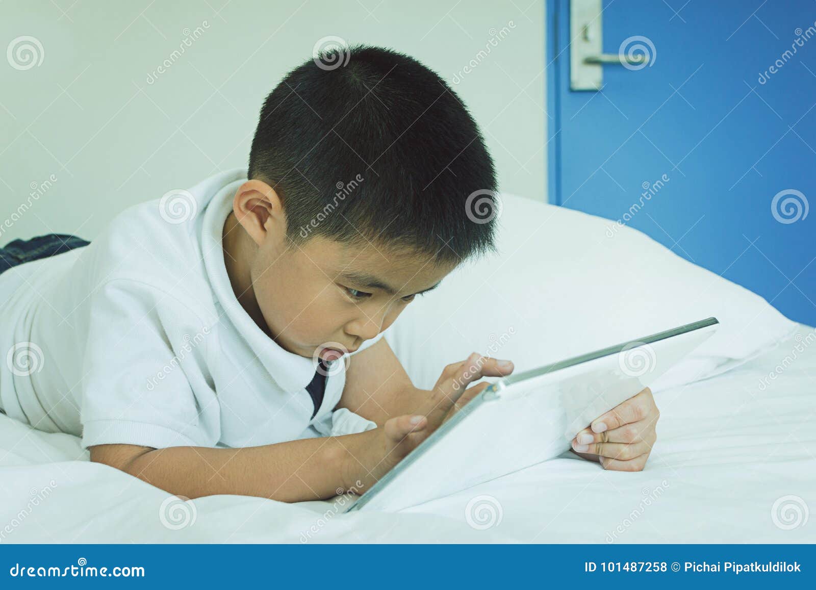 Asian Little Boy Using Tablet Computer in Bed Stock Photo - Image of ...