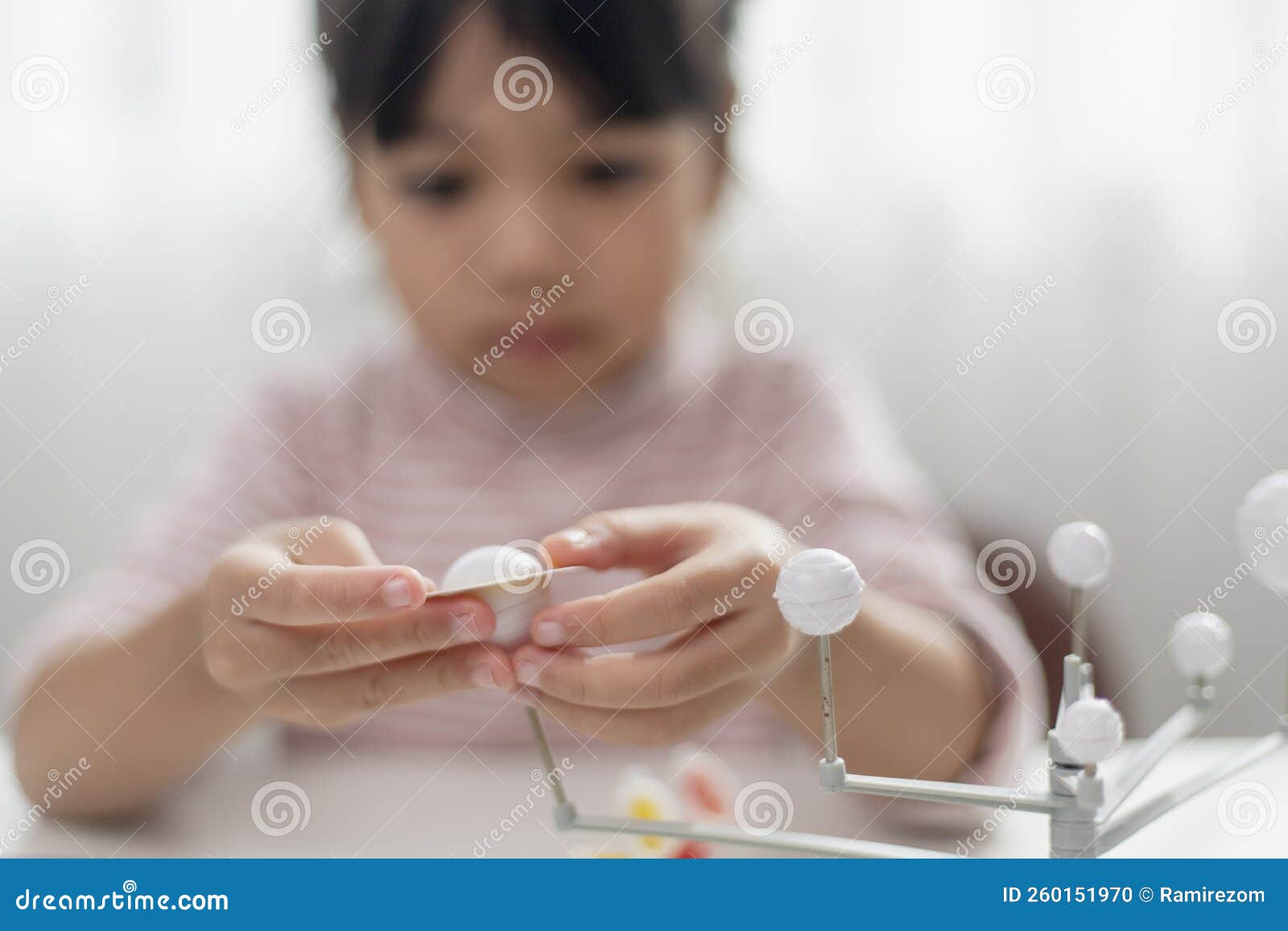 Asian Little Girl Studies the Solar System in Geography Class. Looking ...