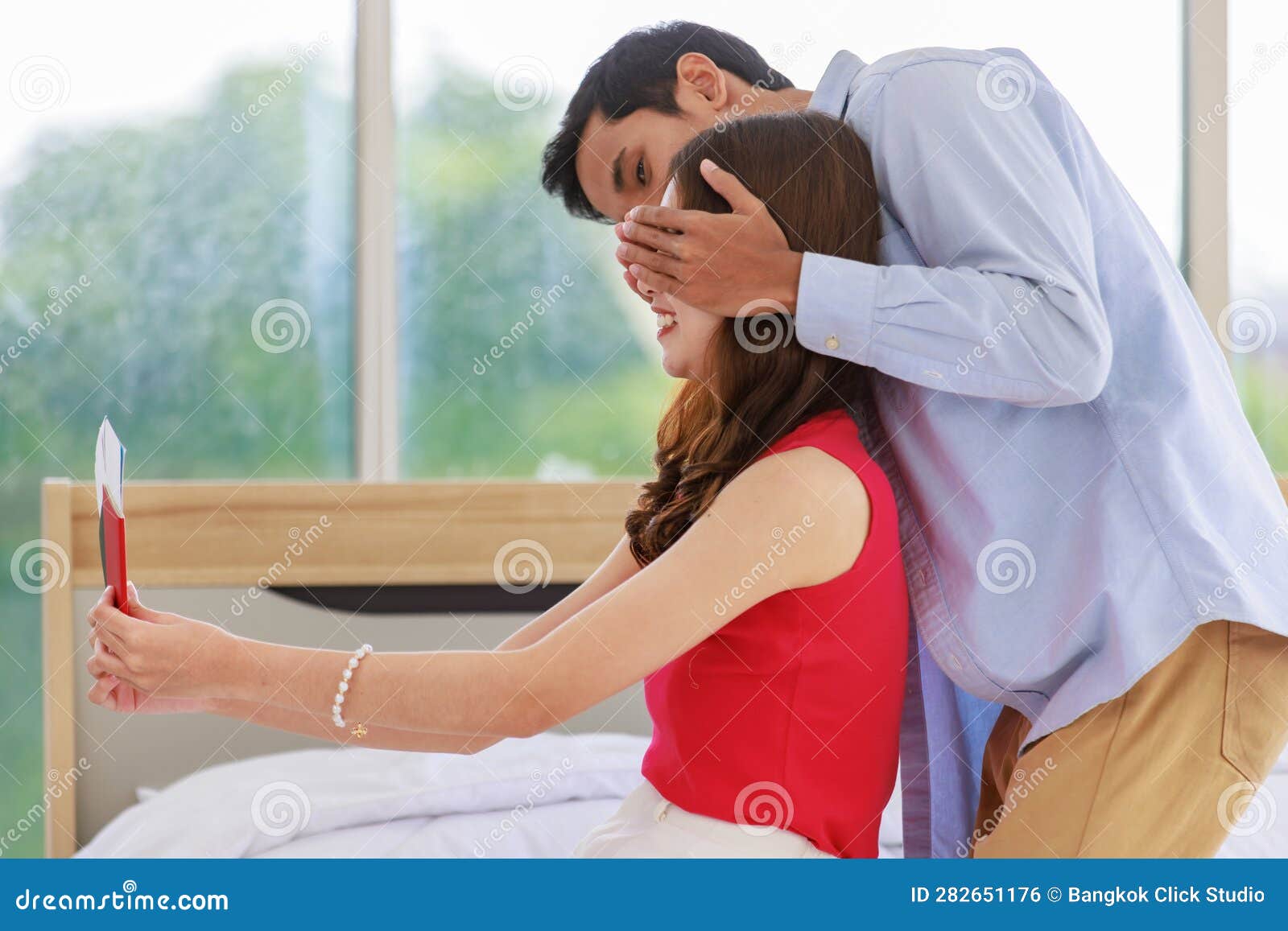Asian Lovely Handsome Husband Surprise Beautiful Happy Smiling Wife By Closed Eyes And Give