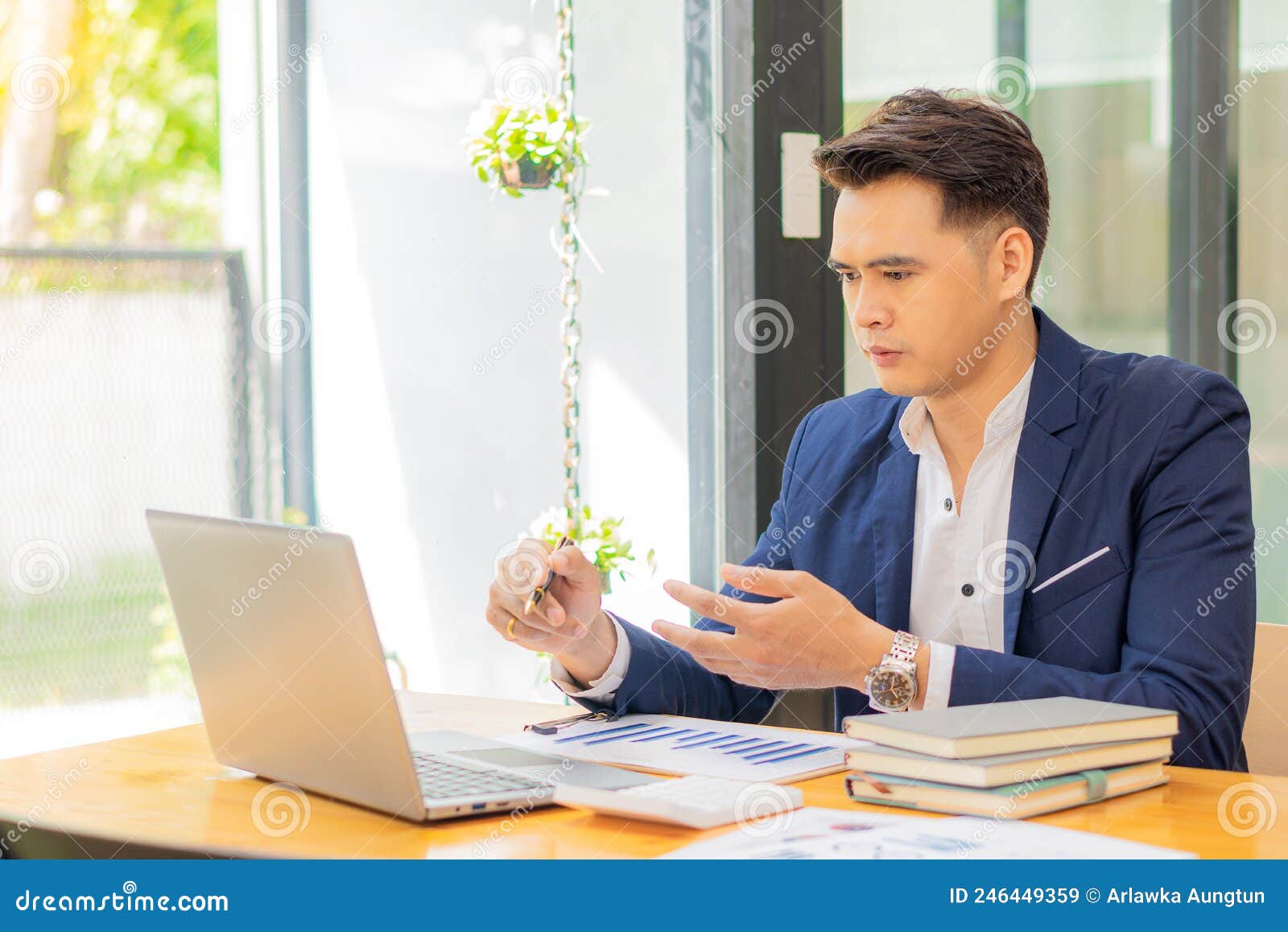 Asian Male Businessman with Documents and Laptop Computer Doing ...