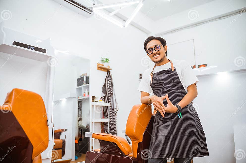 Asian Male Hairstylist Leaning on Barber Chair with Smiling Face Stock ... Asian Male Hairstylist Leaning on Barber Chair with Smiling Face Stock ...