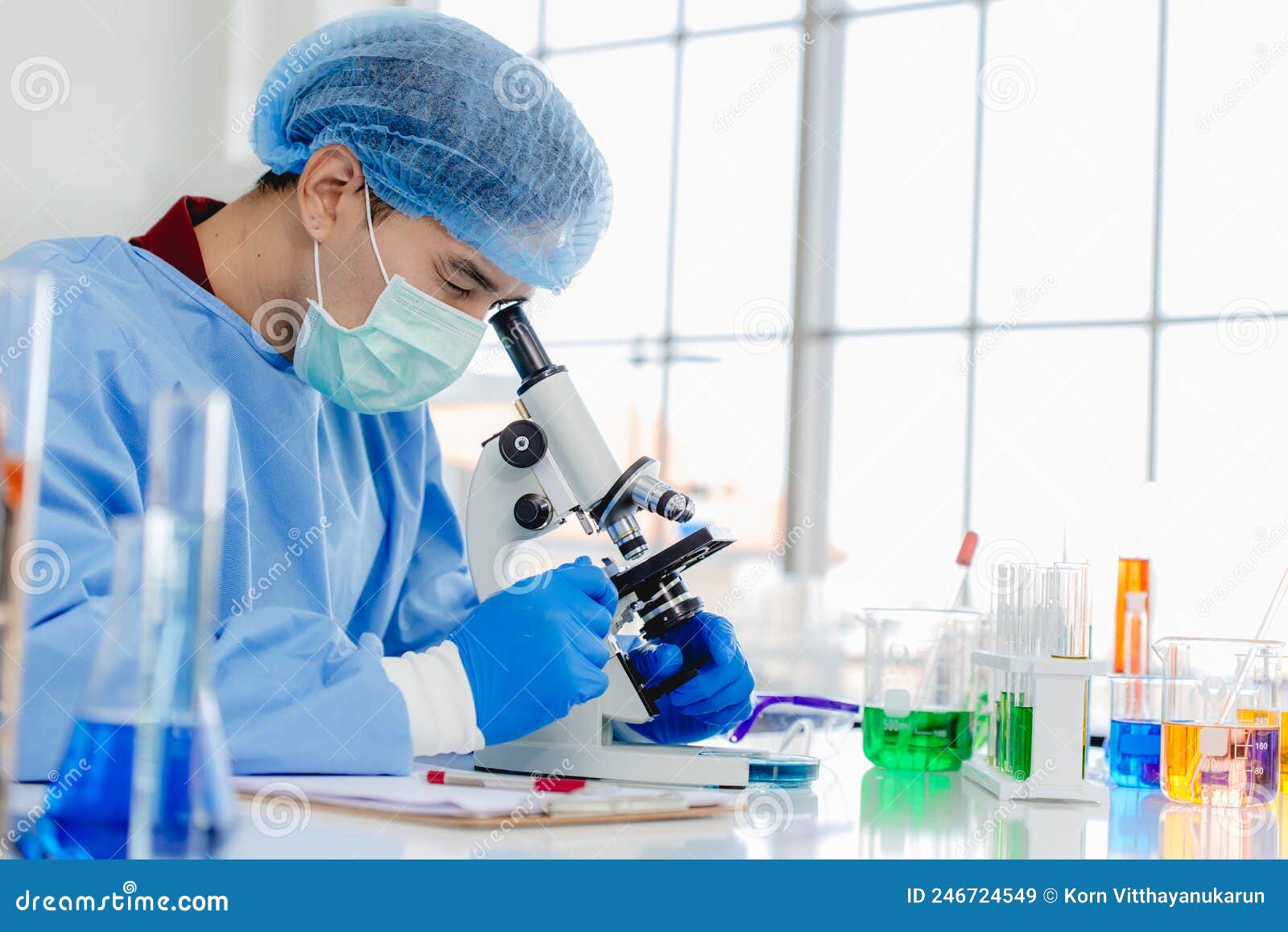 Asian Male Researcher in Laboratory or Chemist Notes while Studying ...