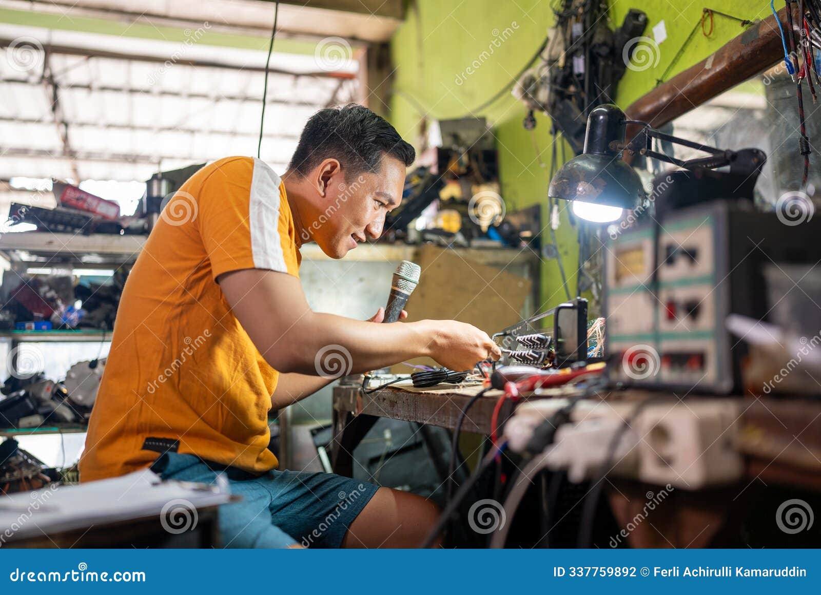 Asian Male Technician Fixes Broken Cable in Electronics Repair Room ...