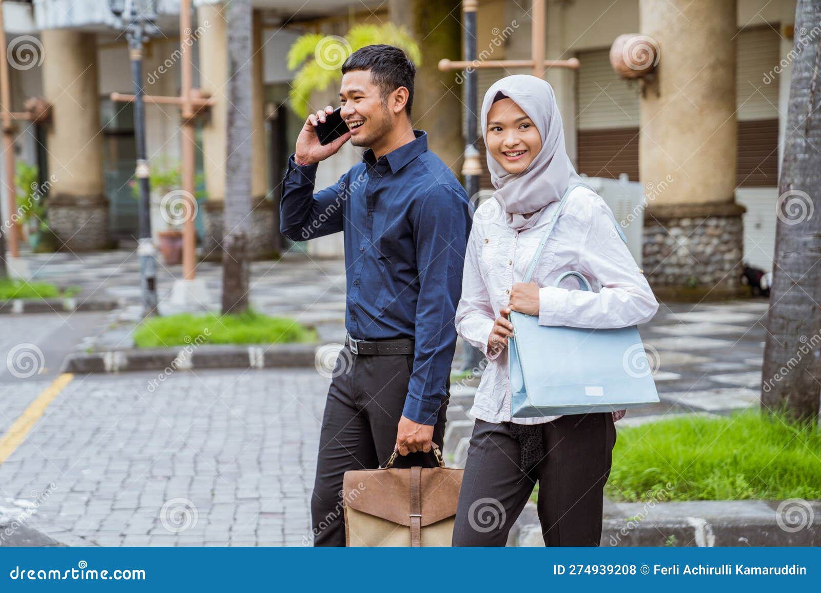 Asian Male and Veiled Female Workers Leave for Work Stock Photo - Image ...