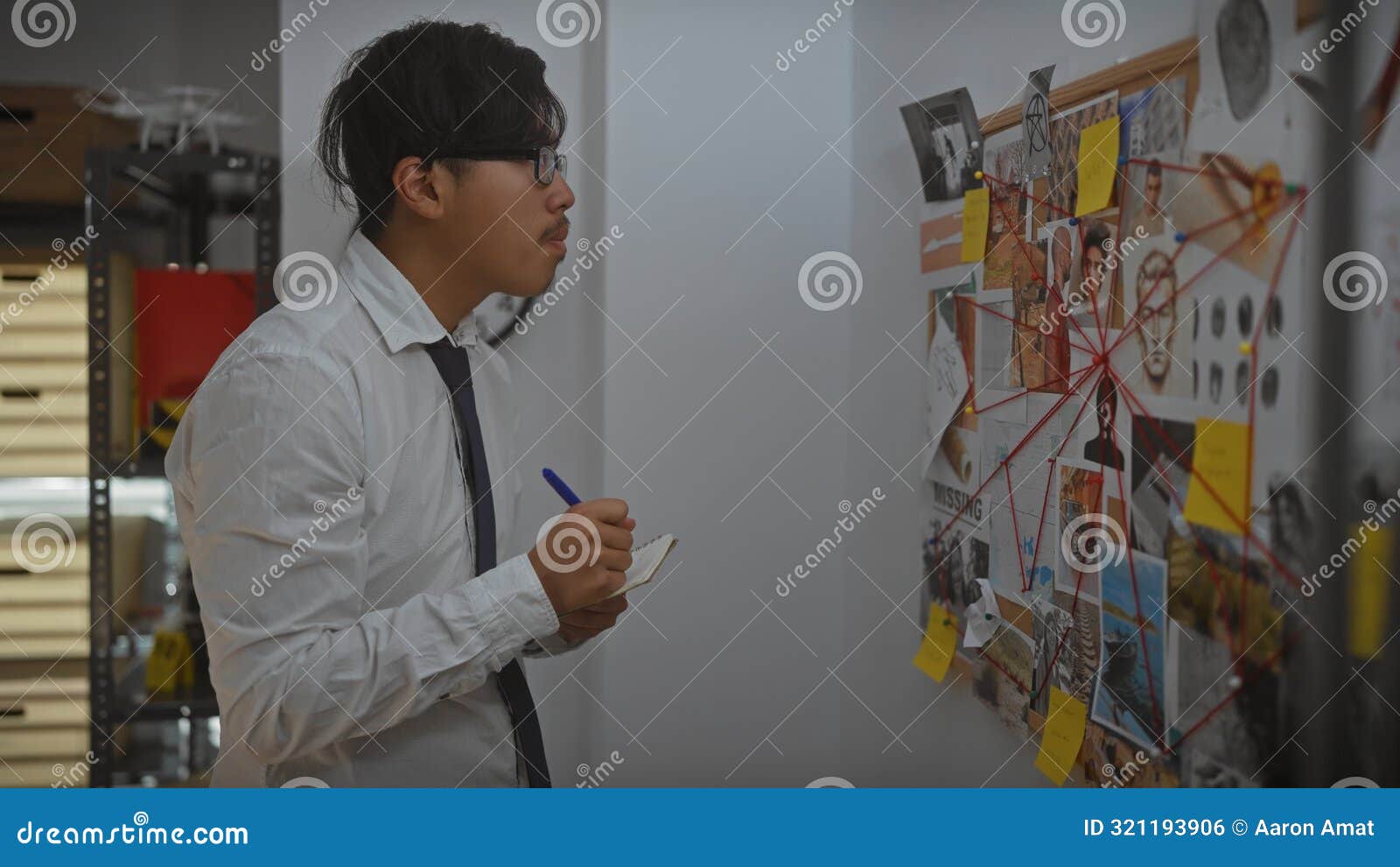 Asian Man Analyzing Evidence Board in Detective Office Setting Stock ...