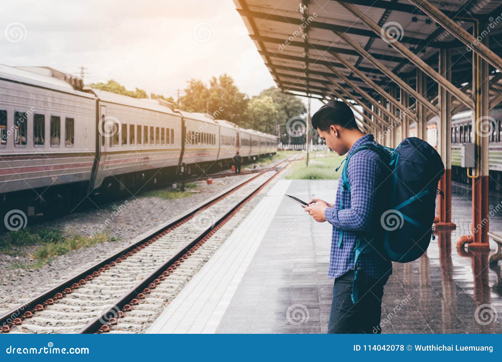 Asian Man Backpack for Travel at Train Station and Using Tablet Stock ...