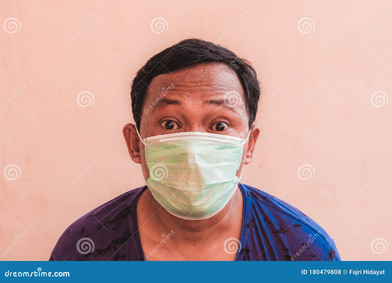 Asian Man Wearing a Blue T-shirt and Wearing a Face Mask Stock Photo ...