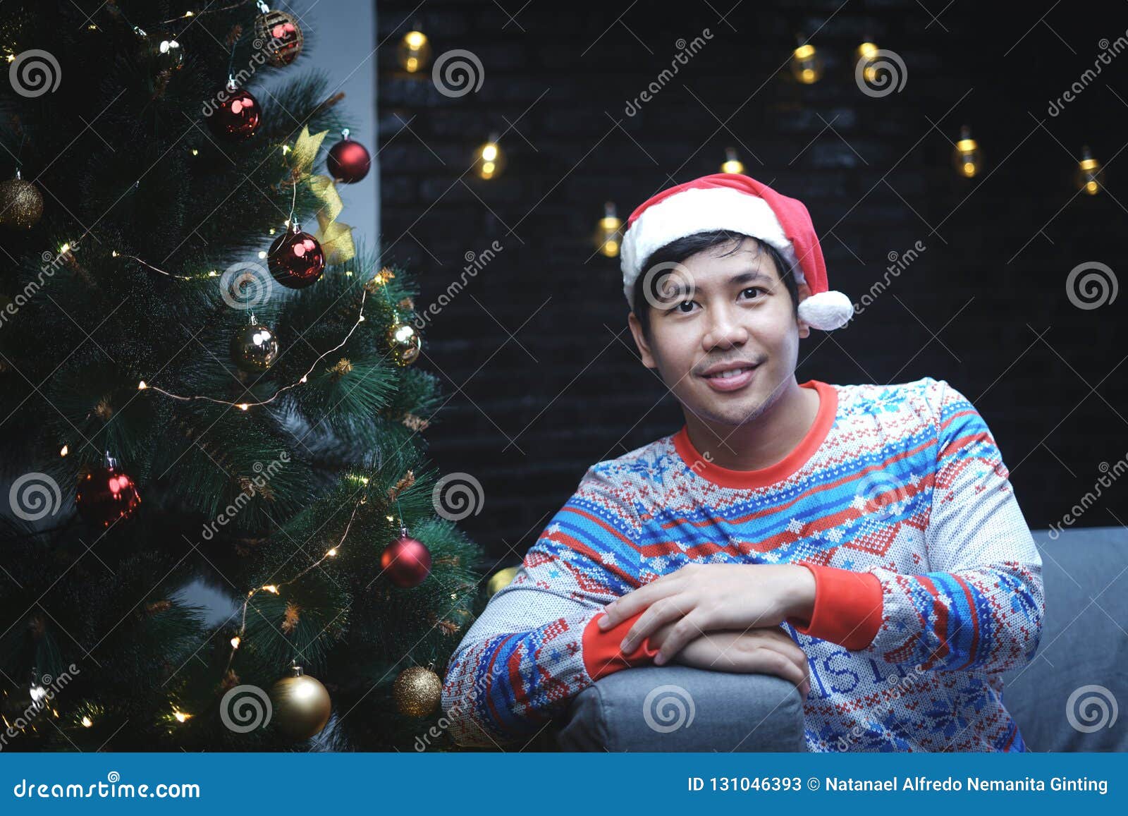 Asian Man with Christmas Costume Sitting beside Christmas Tree Stock ...