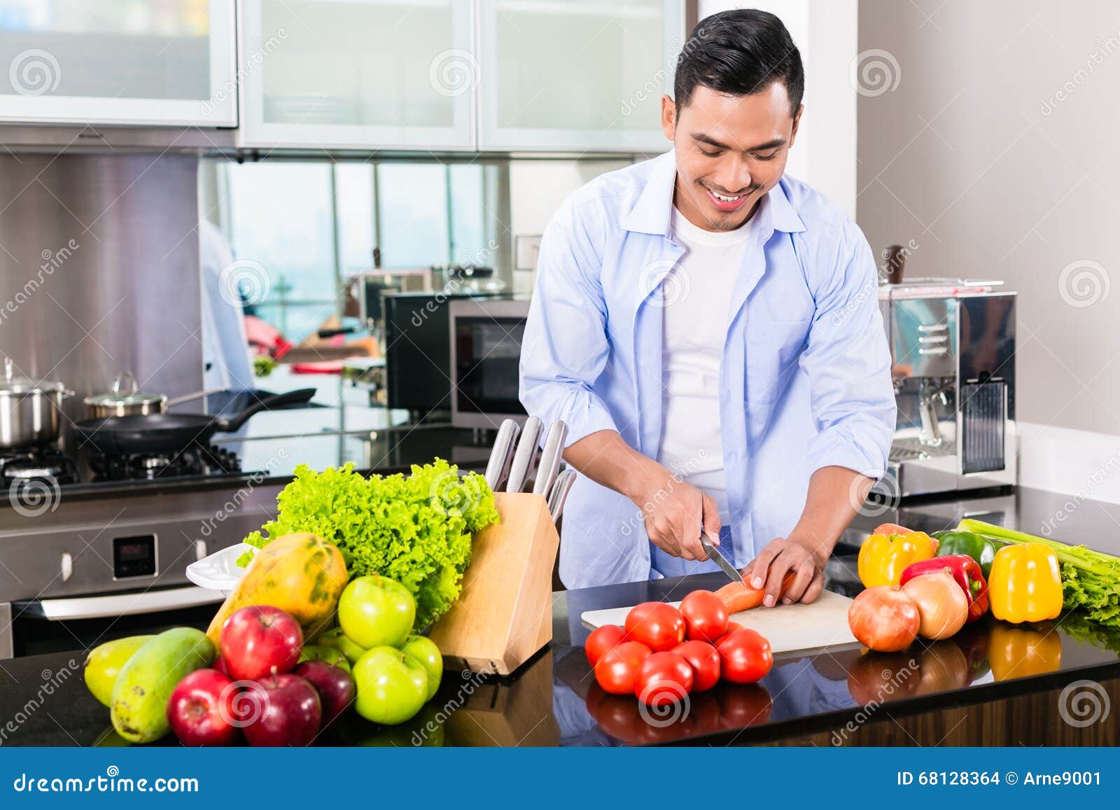 Asian Man Cutting Salad in Kitchen Stock Photo - Image of vegetables ...