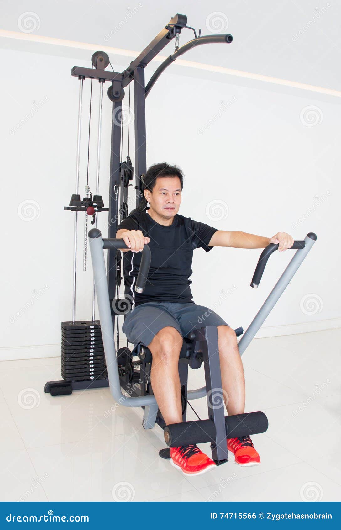 Asian Man Doing Exercise on Fitness Machine. Stock Photo - Image of ...