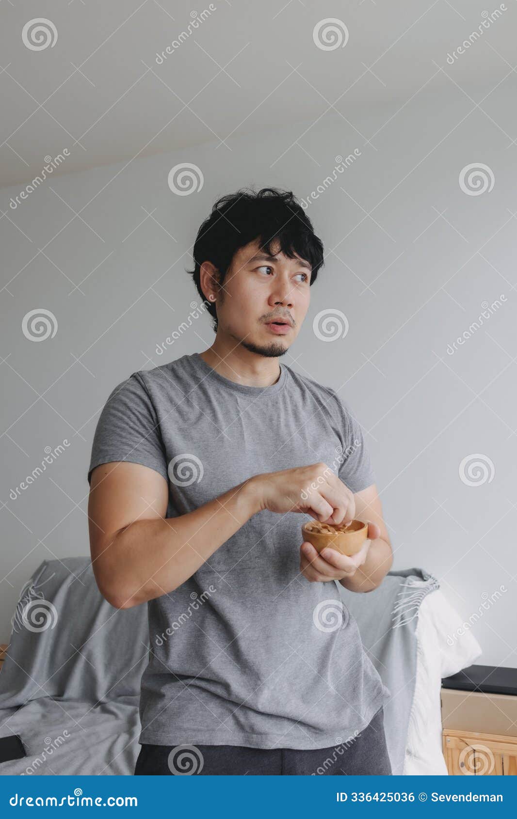 Man Eating Peanuts Standing at the Windows in the Morning. Stock Photo ...
