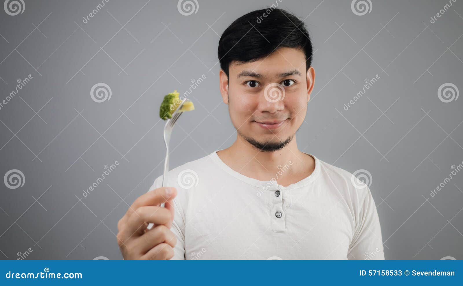 An Asian Man Eats Broccoli. Stock Image - Image of healthy, smile: 57158533