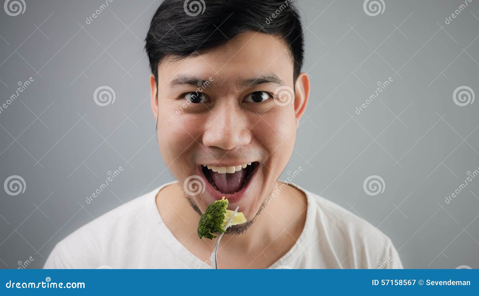 An Asian Man Eats Broccoli. Stock Image - Image of table, people: 57158567