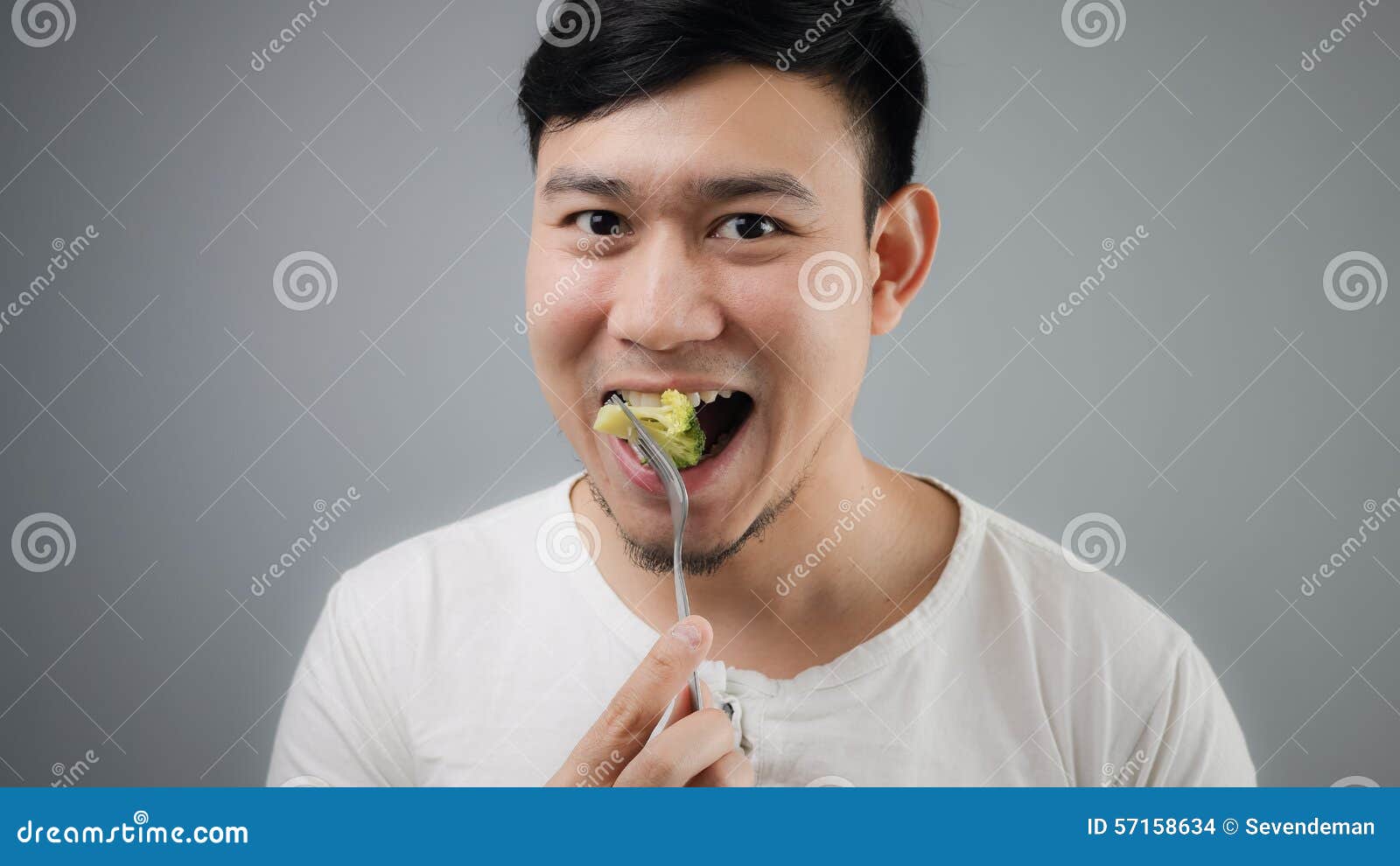 An Asian Man Eats Broccoli. Stock Photo - Image of fresh, diet: 57158634