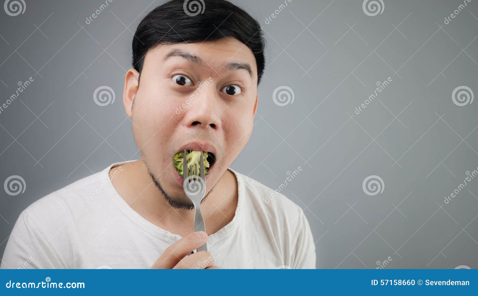 An Asian Man Eats Broccoli. Stock Photo - Image of broccoli, smile ...
