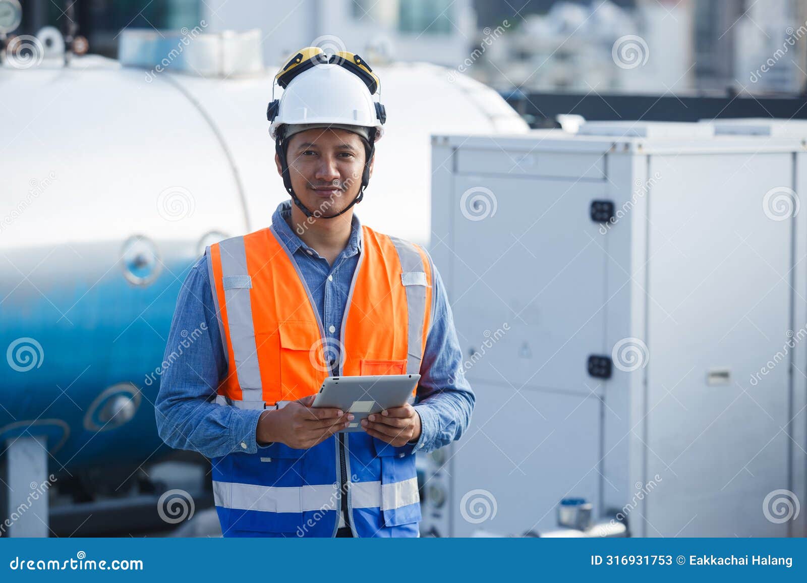 Asian Man Engineer Holding Tablet Working at Rooftop Building Construction. Male Technician ...