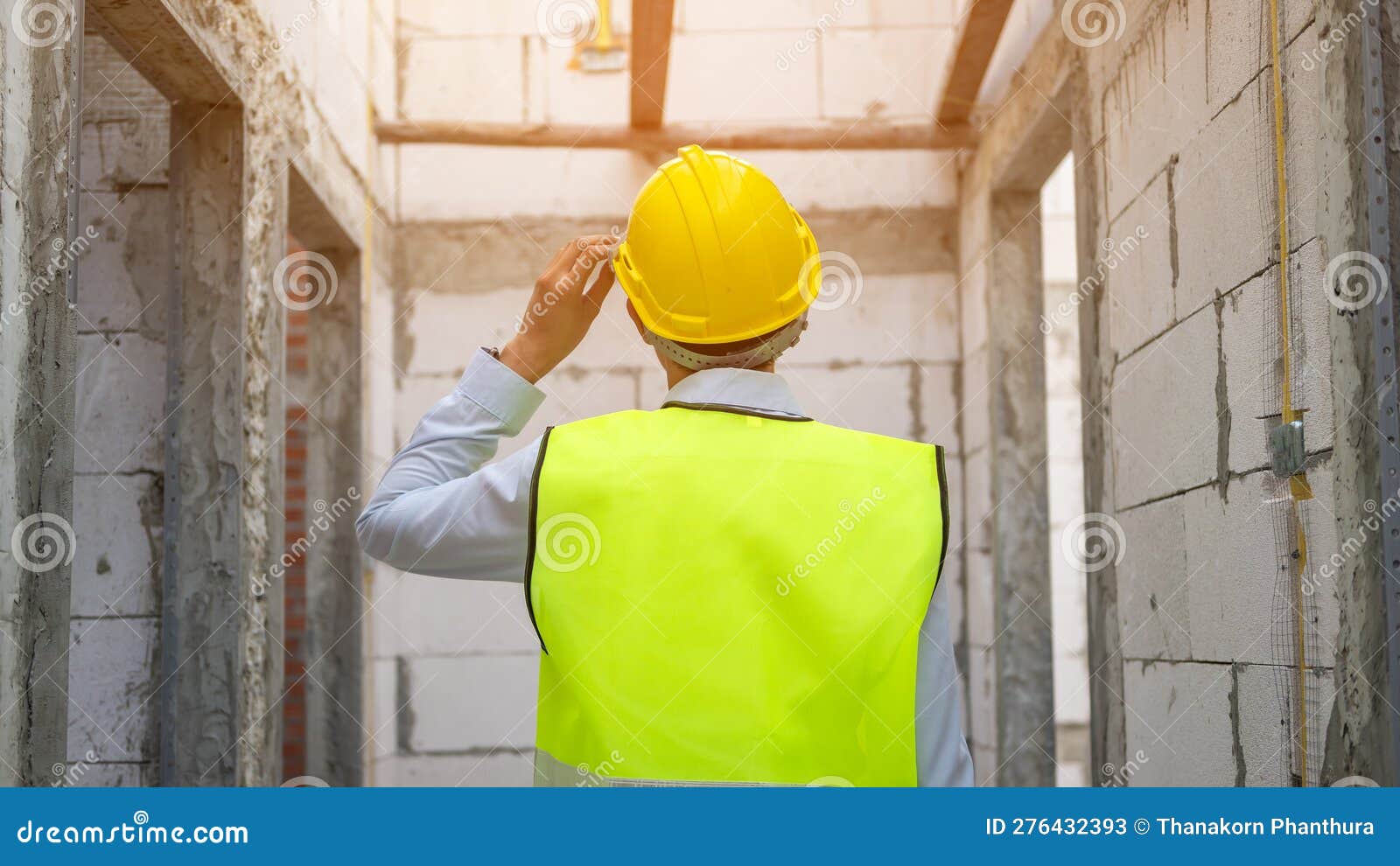 Asian Man Engineer is Putting a Protective Helmet on His Head Stock ...