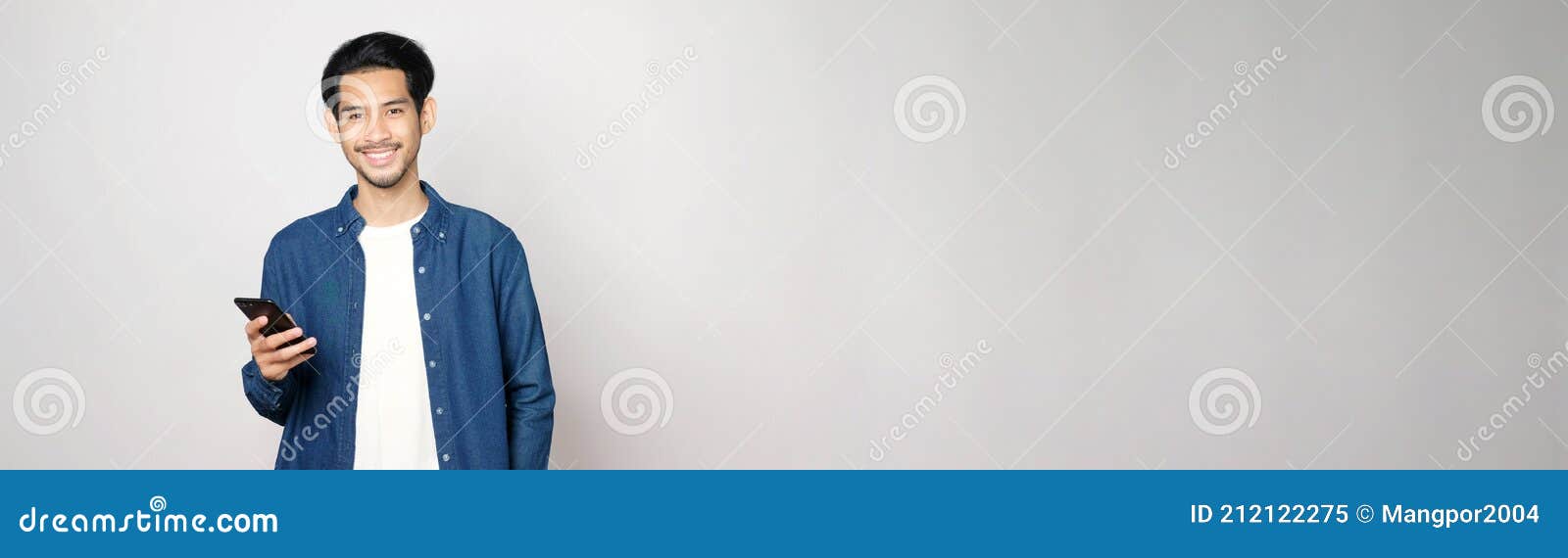 Asian Man Holding Mobile Phone Smiling Lokking At Camera While