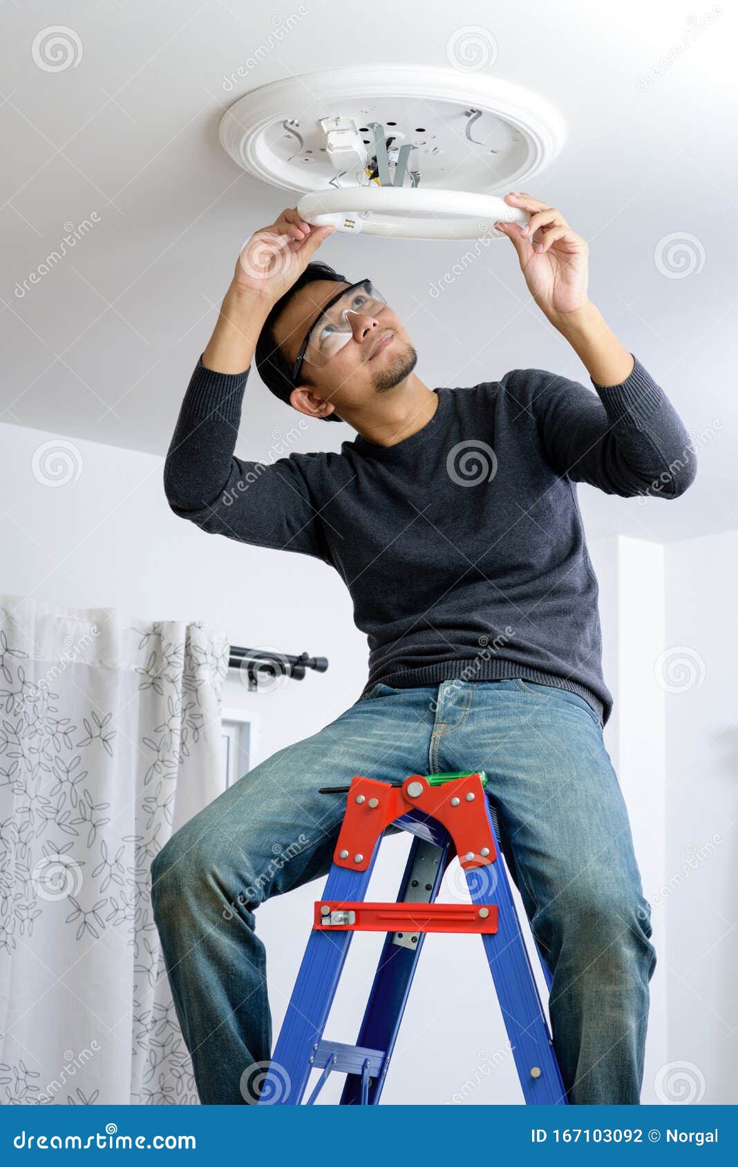 Installing light bulb stock photo. Image of electrician - 167103092
