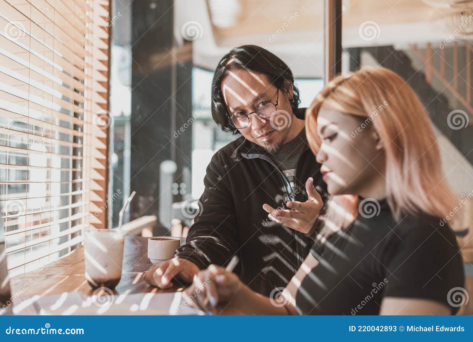 An Asian Man Instructs an Intern on Some Tasks at the Office. Typical ...