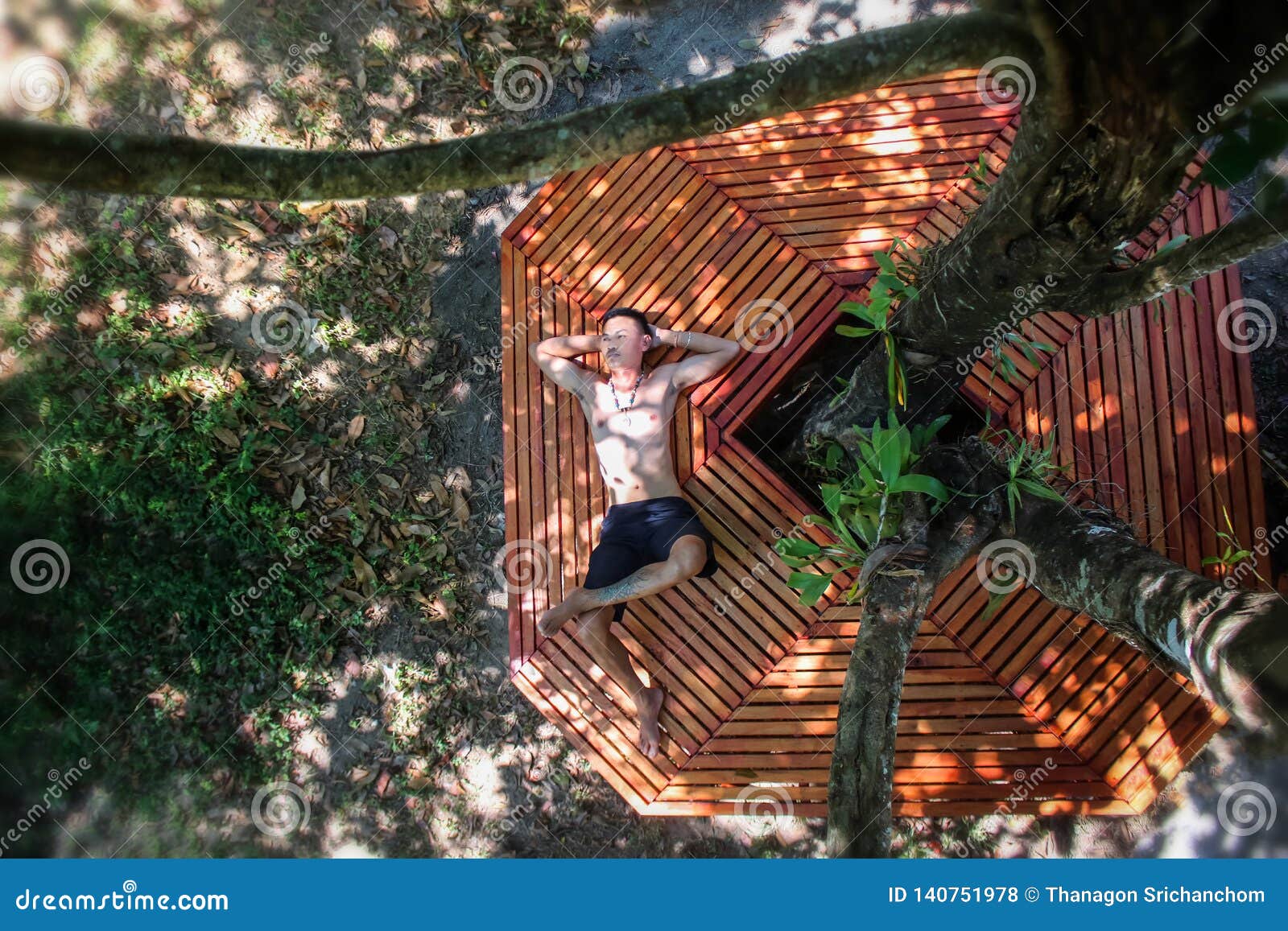 Asian Man Lying on the Outdoor Seating Under the Tree during Summer ...