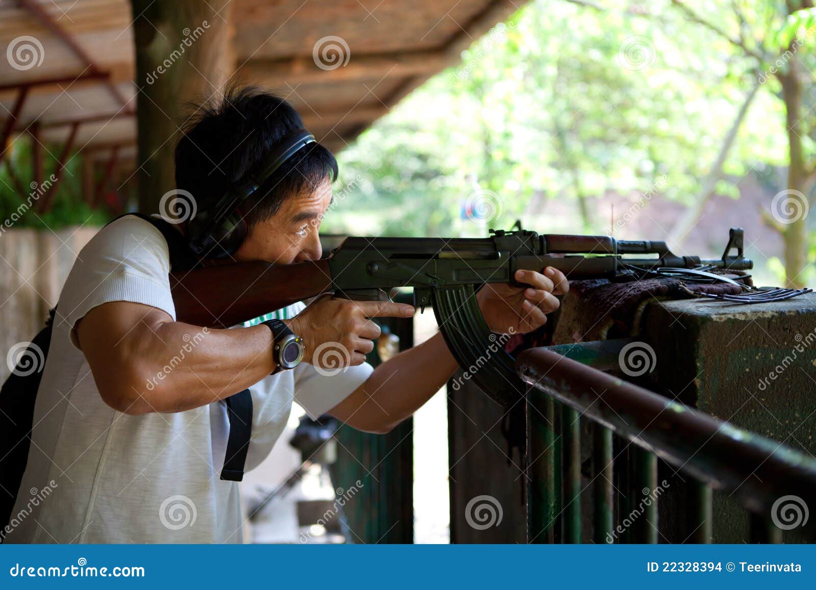 Asian Man With A Rifle In Ready Position Stock Photo | CartoonDealer ...