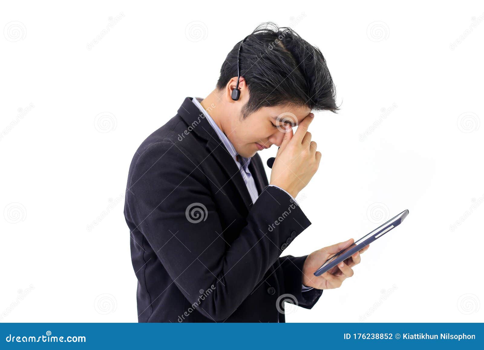 Asian Man Serious Call Center Operator in Wireless Headset Talking with ...