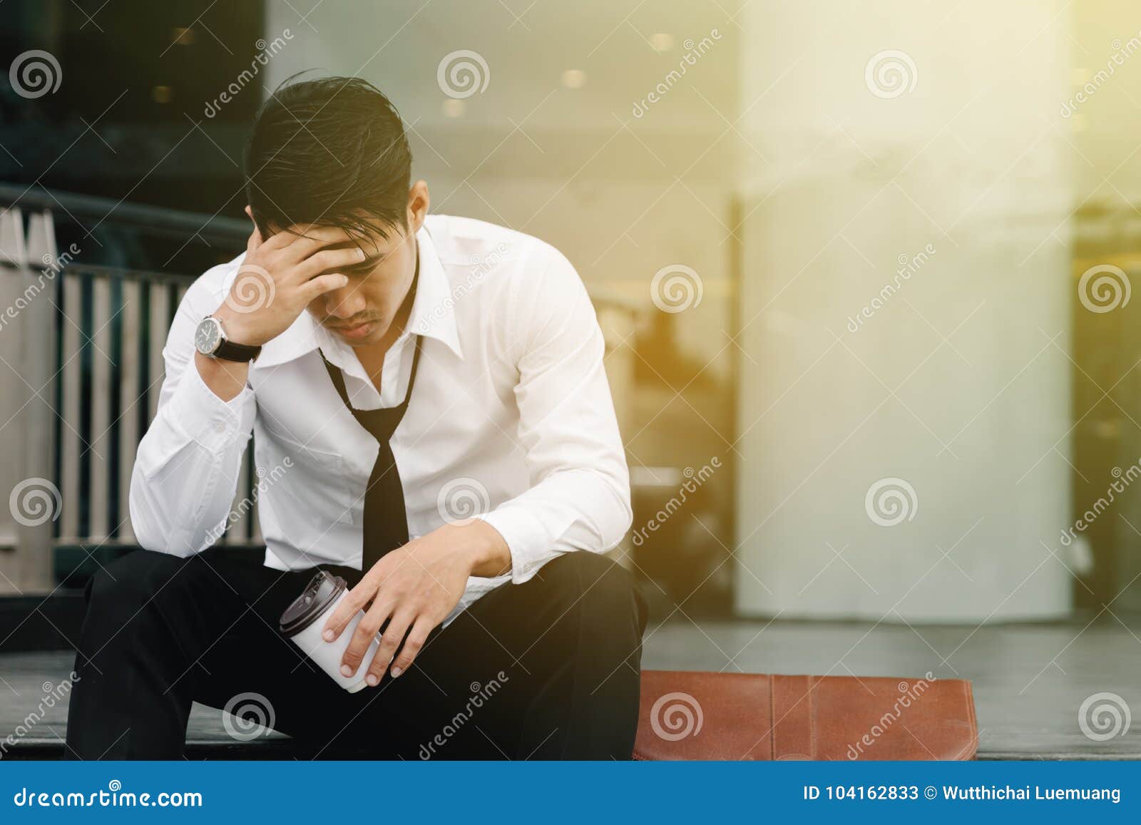 Asian Man Sits on the Steps of an Office Building with Stress an Stock ...