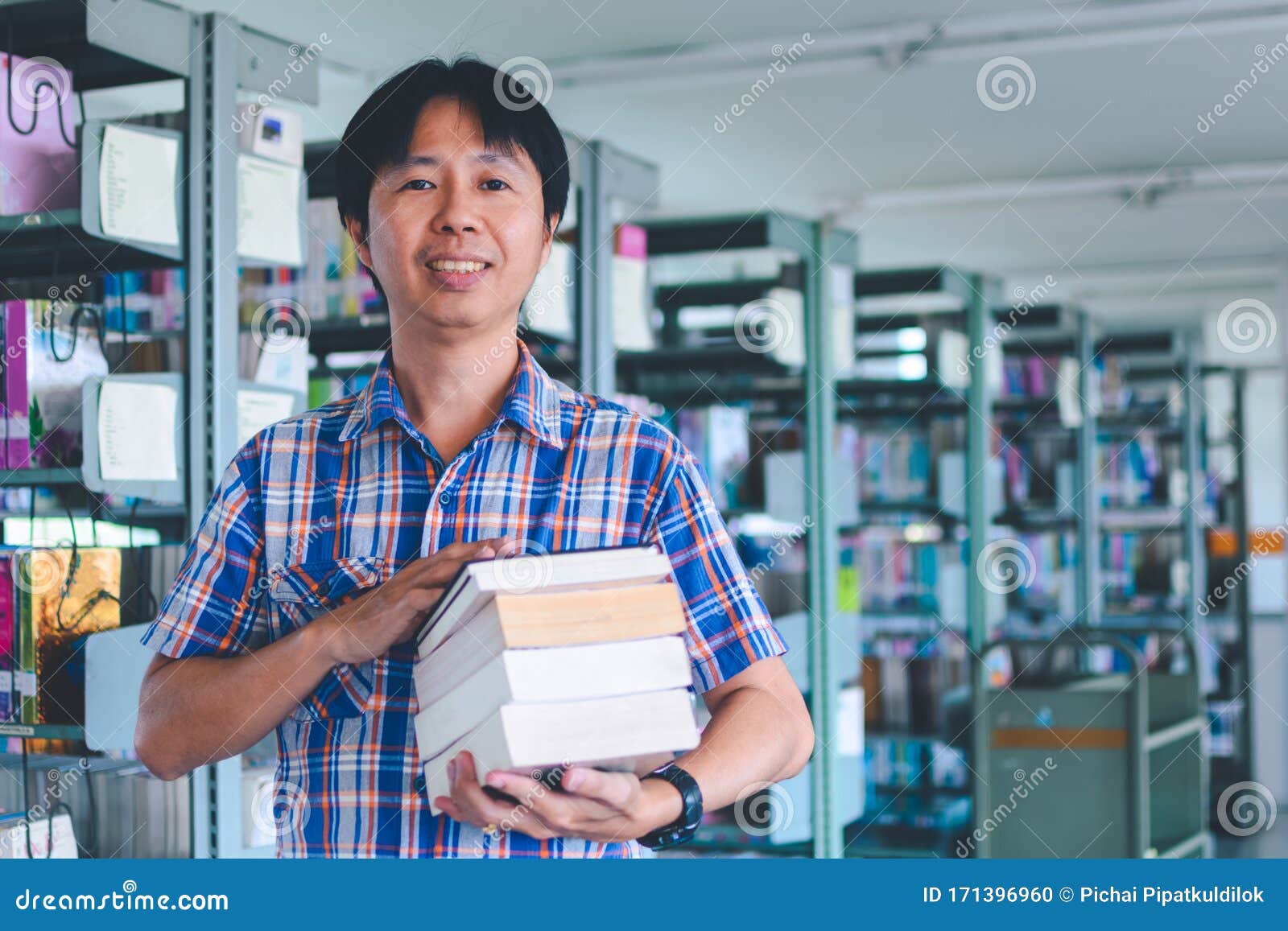 Asian Man Student Hold Books in a Library Stock Photo - Image of male ...