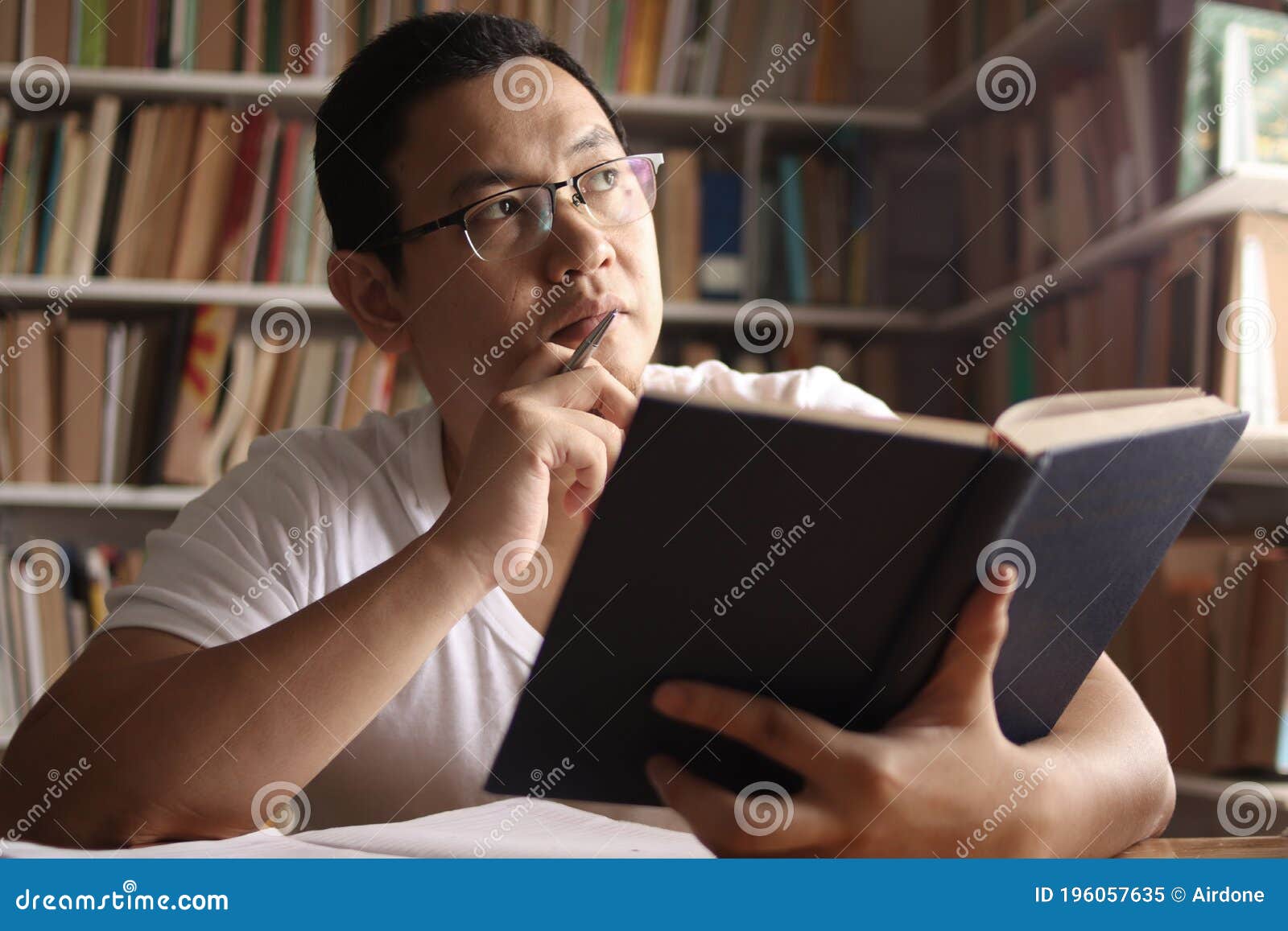 Asian Man Thinking while Reading Book, Education Concept, Learning ...