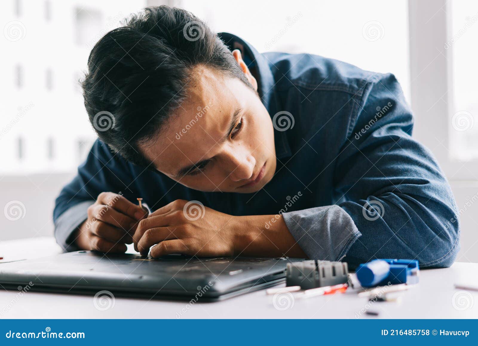 The Asian Man Was Taking Out a Broken Computer To Repair it Stock Photo ...