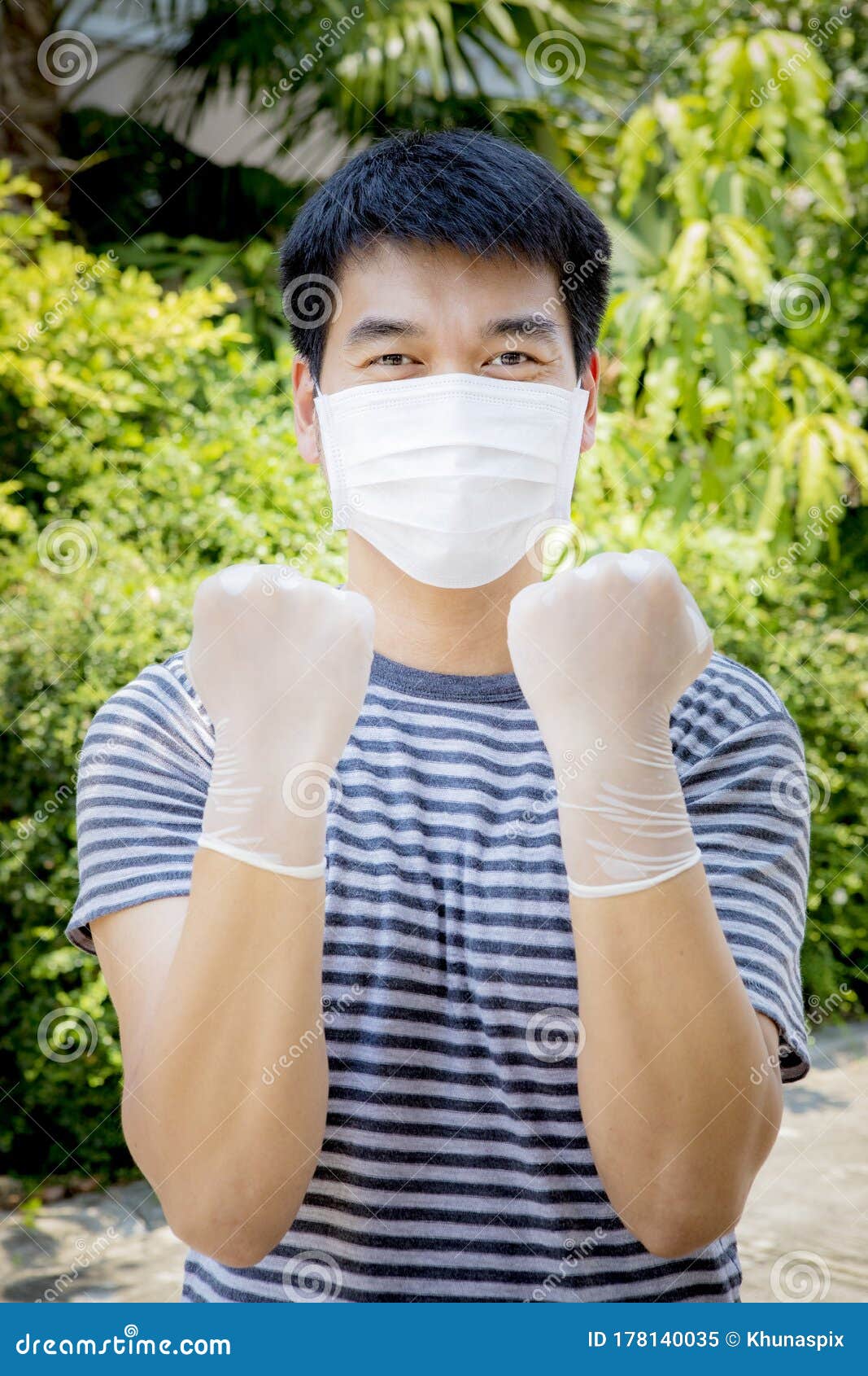 Asian Man Wearing Protection Mask And Rubber Hand Glove Standing