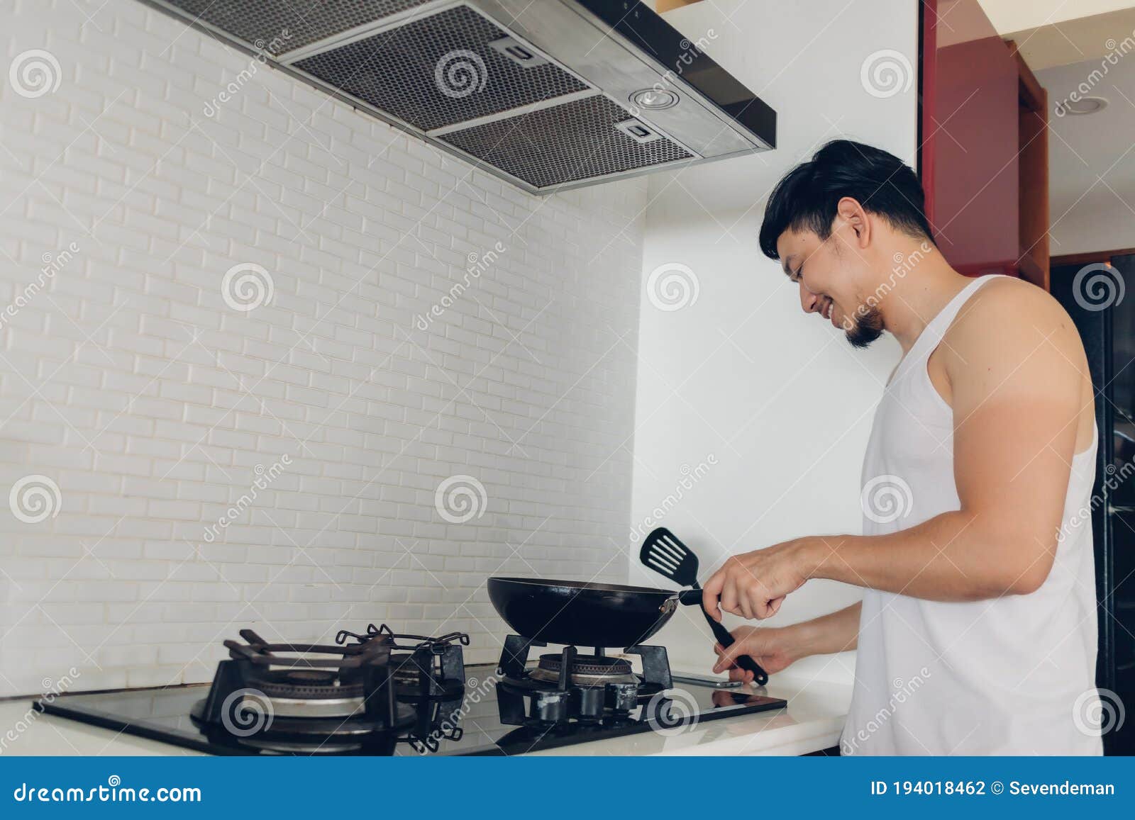 Man in White Tank-top is Cooking Breakfast in the Kitchen. Stock Photo ...