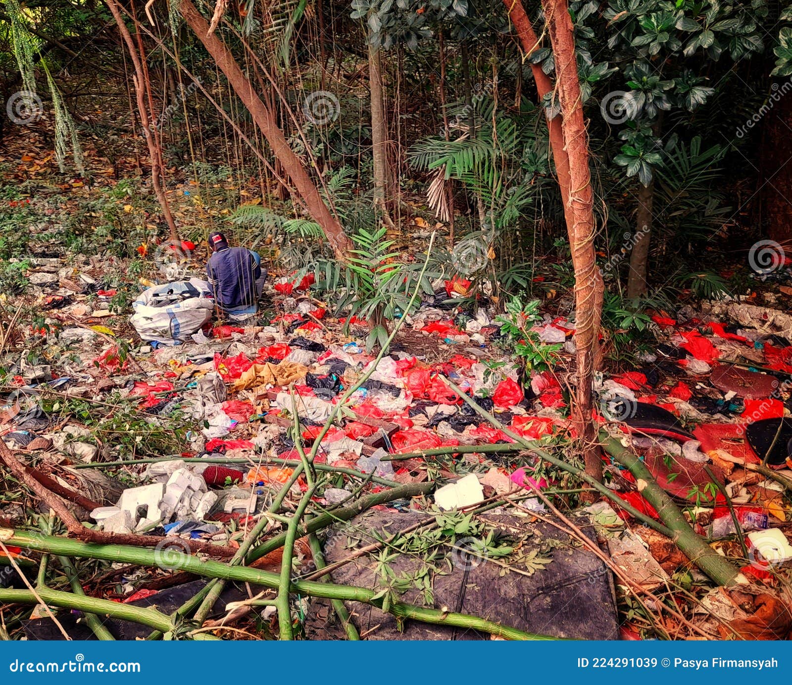 An Asian Man Who Works As a Scavenger is Working on a Pile of Garbage ...