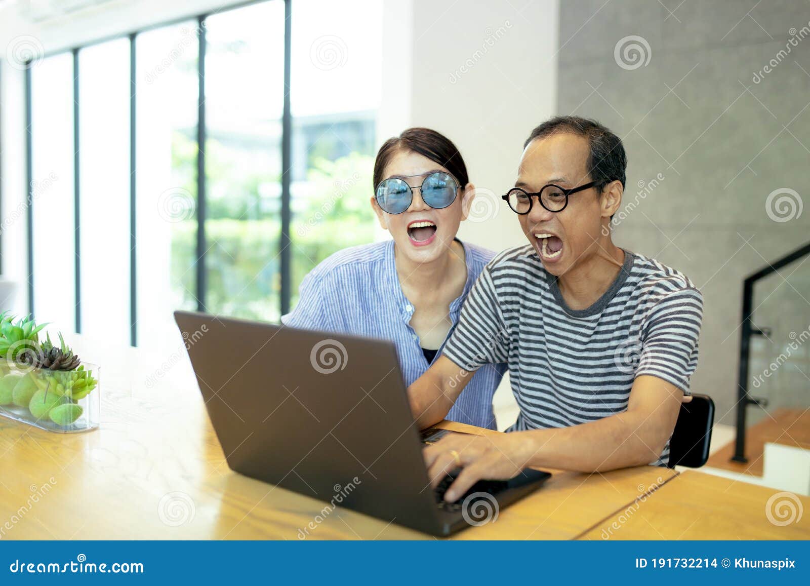 Asian Man and Woman Make a Exciting Face and Looking To Computer Screen ...