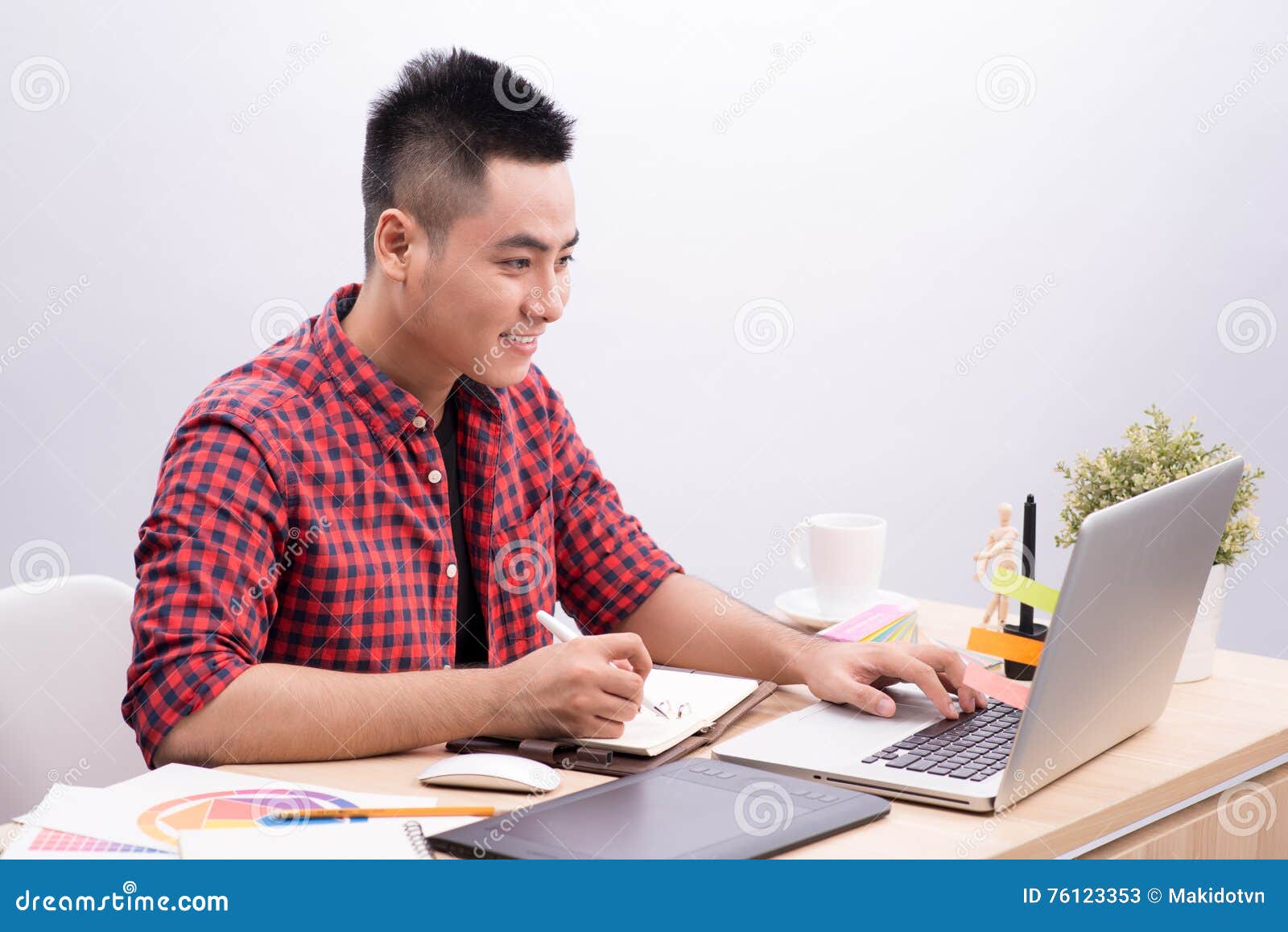 Asian Man Writing at Desk in Busy Creative Office Stock Image - Image ...