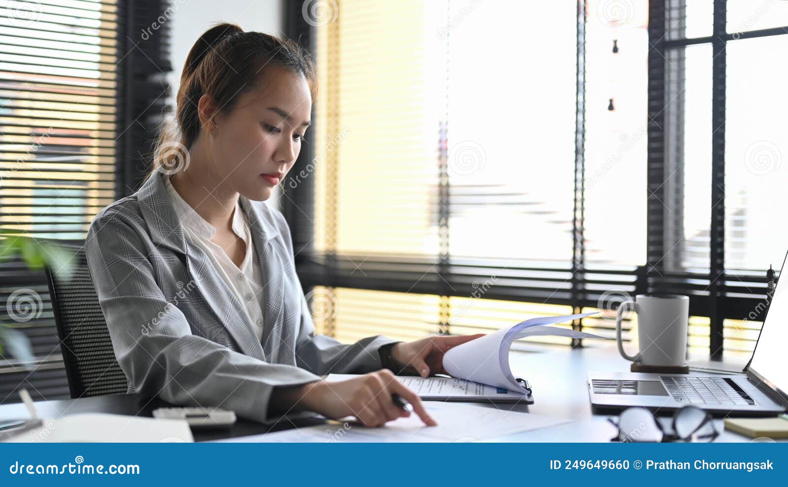 Asian Manager Managing Company Operations, Analyzing Commerce Data ...