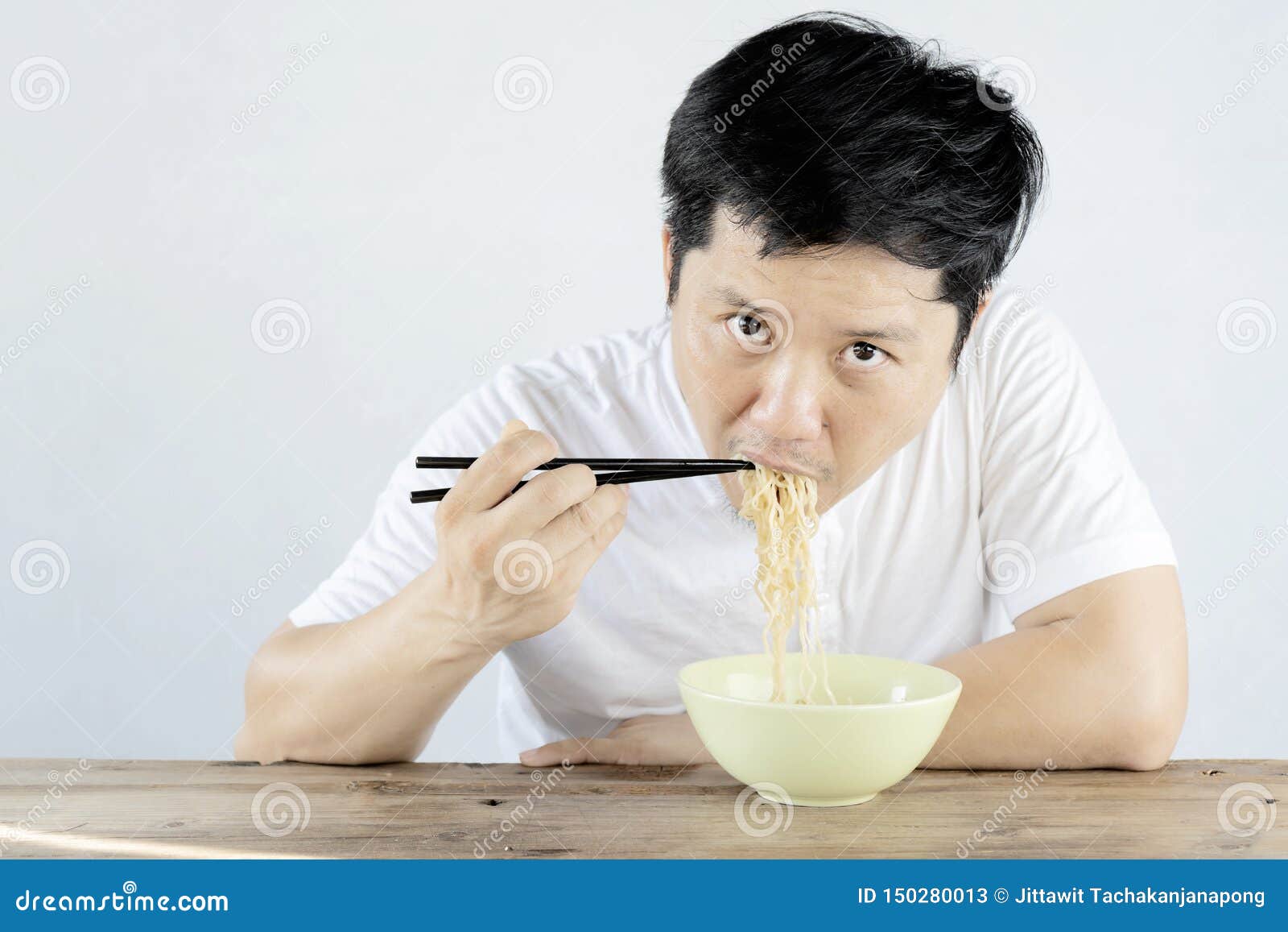 Asian Men Are Eating Instant Noodles With Deliciousness Stock Image