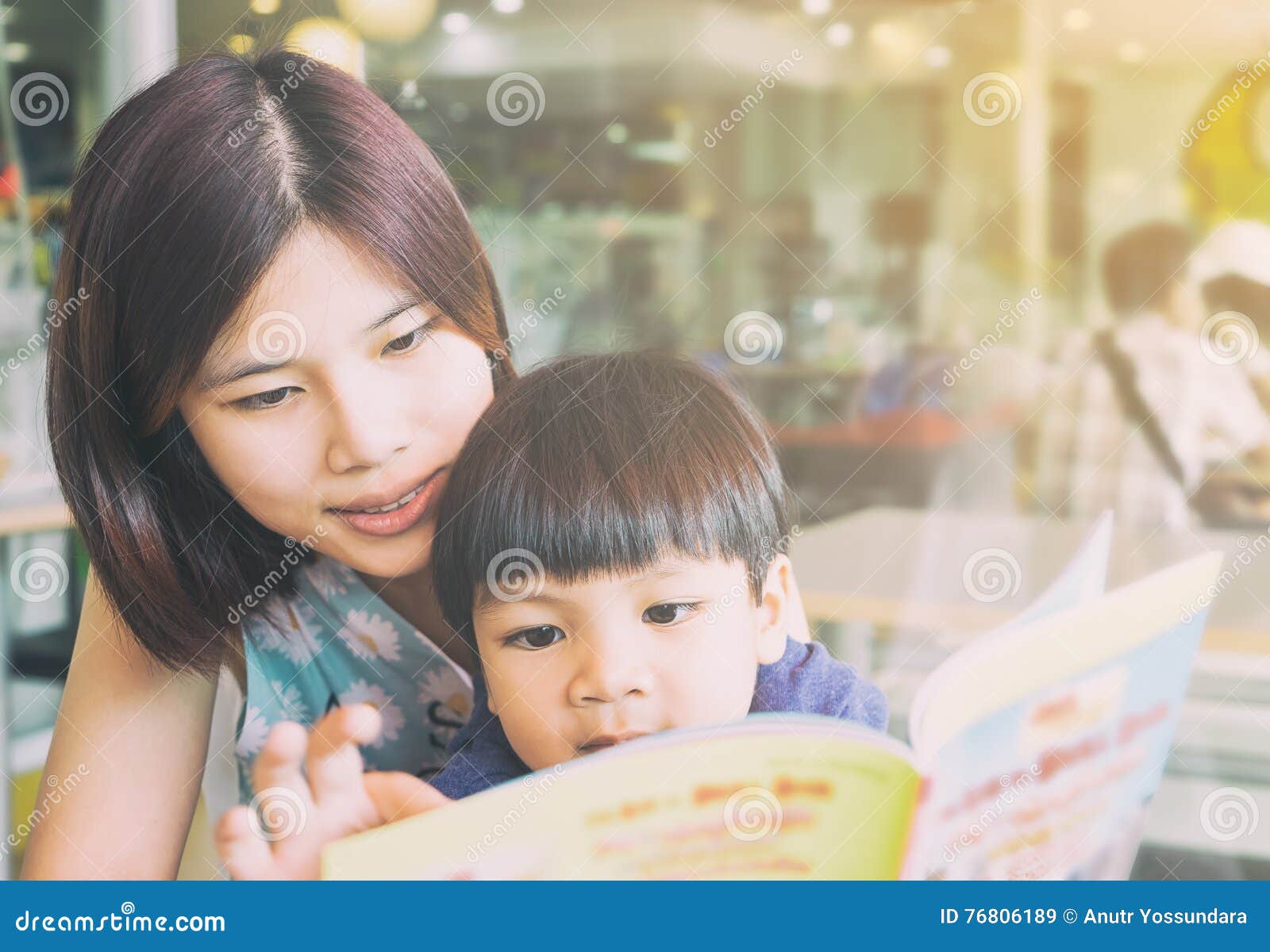 Asian Mother is Reading Her Son an Educational Book. Stock Image ...