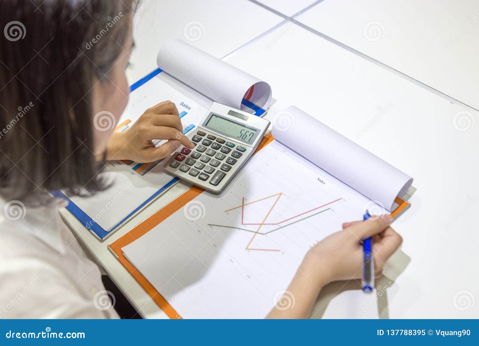 Asian Office Employee Checking Sales Report at Workplace Stock Image ...