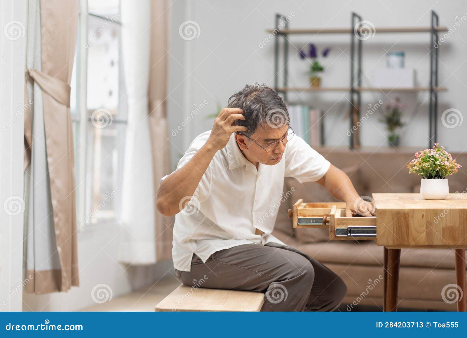 Asian Older Man Finding Something that he Forgot it in Drawers Stock ...