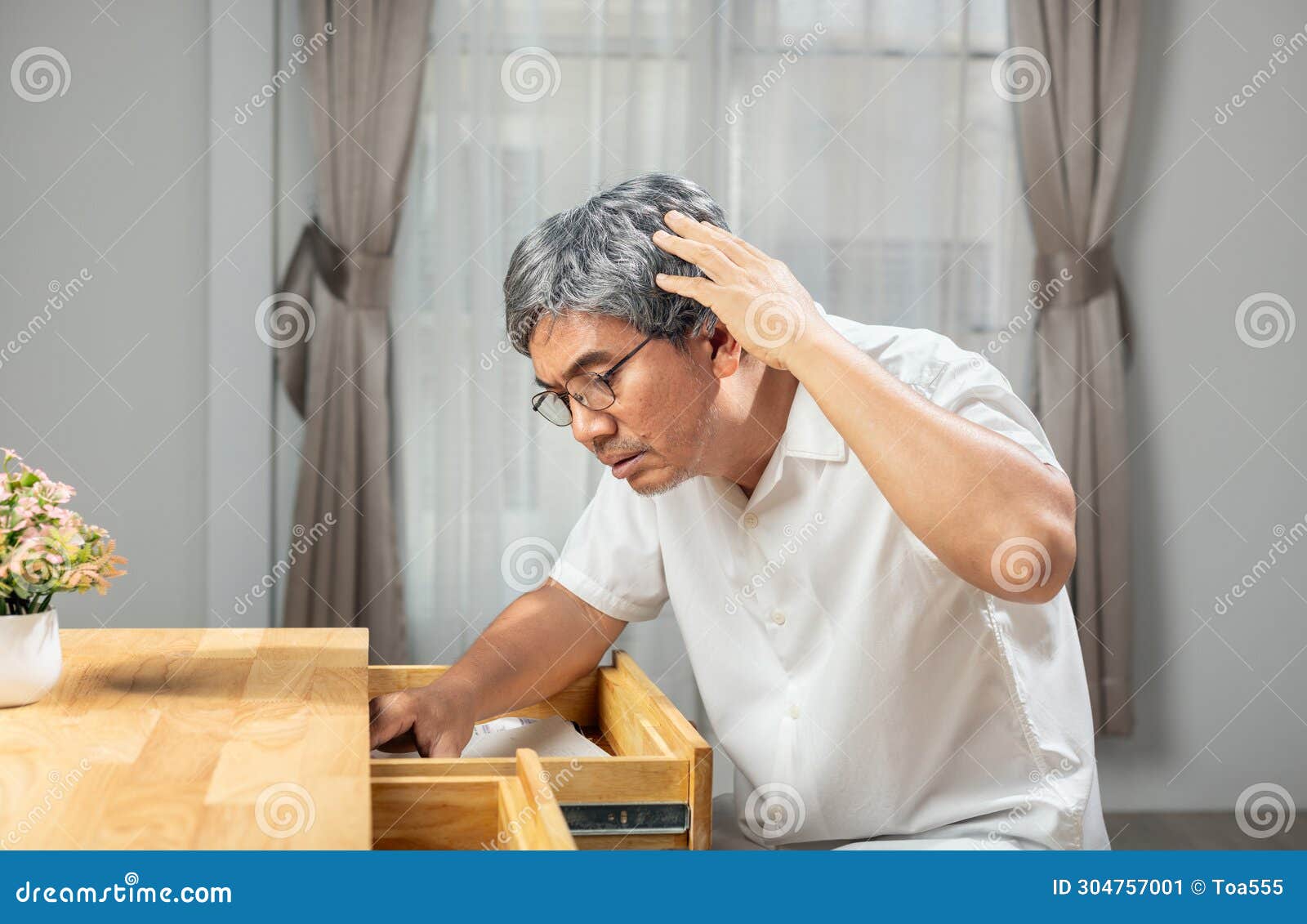Asian Older Man Finding Something that he Forgot it in Drawers Stock ...