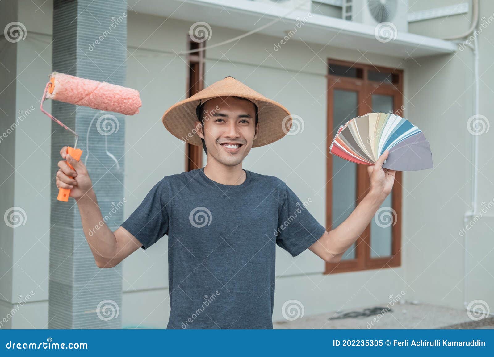 Asian Painter Smiles Wearing a Cap with Raise Hands Holding Paint ...