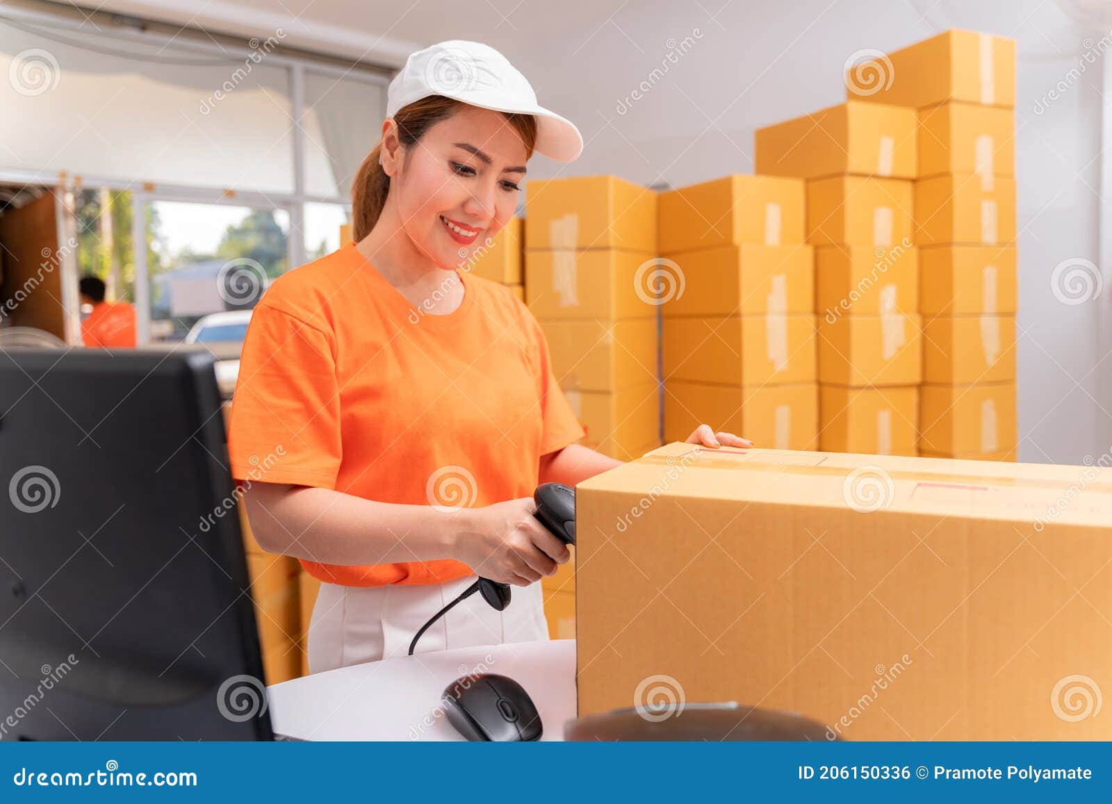 Asian Parcel Delivery Worker in Warehouse with Barcode Scanner Stock ...