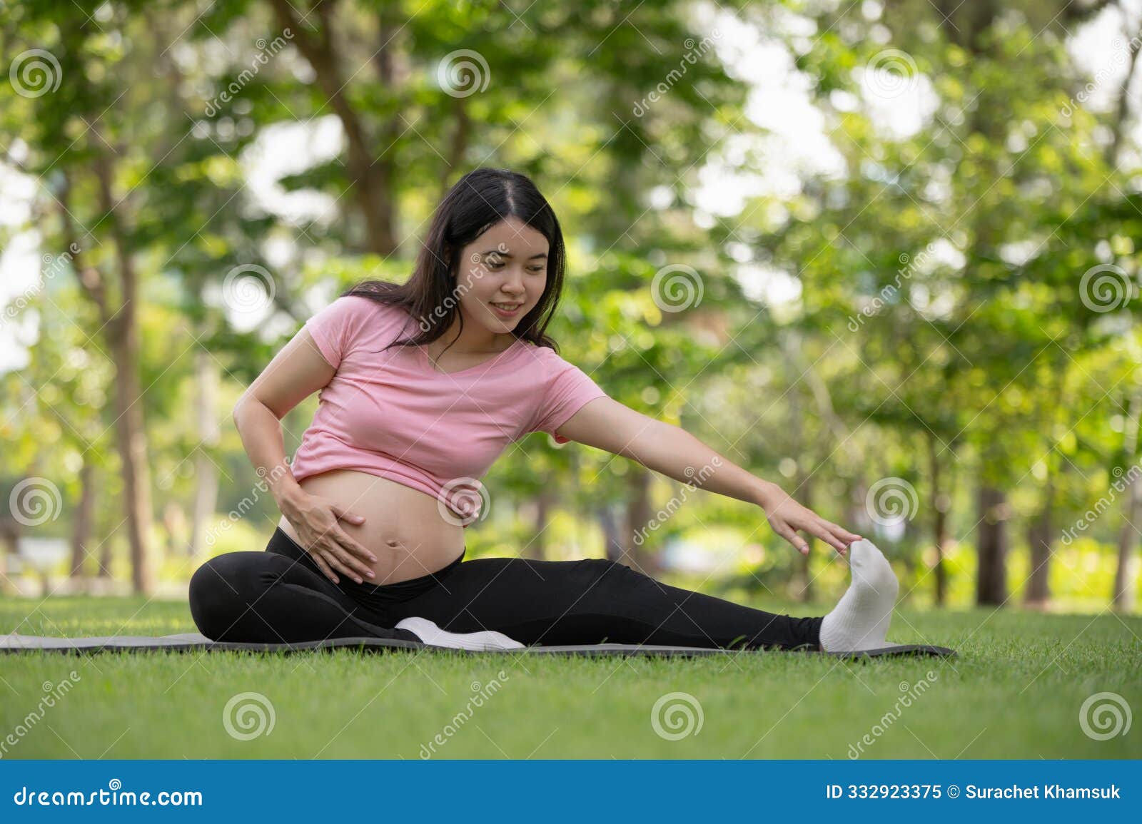 Asian Pregnant Woman Relaxing And Stretching In The Garden Stock Image