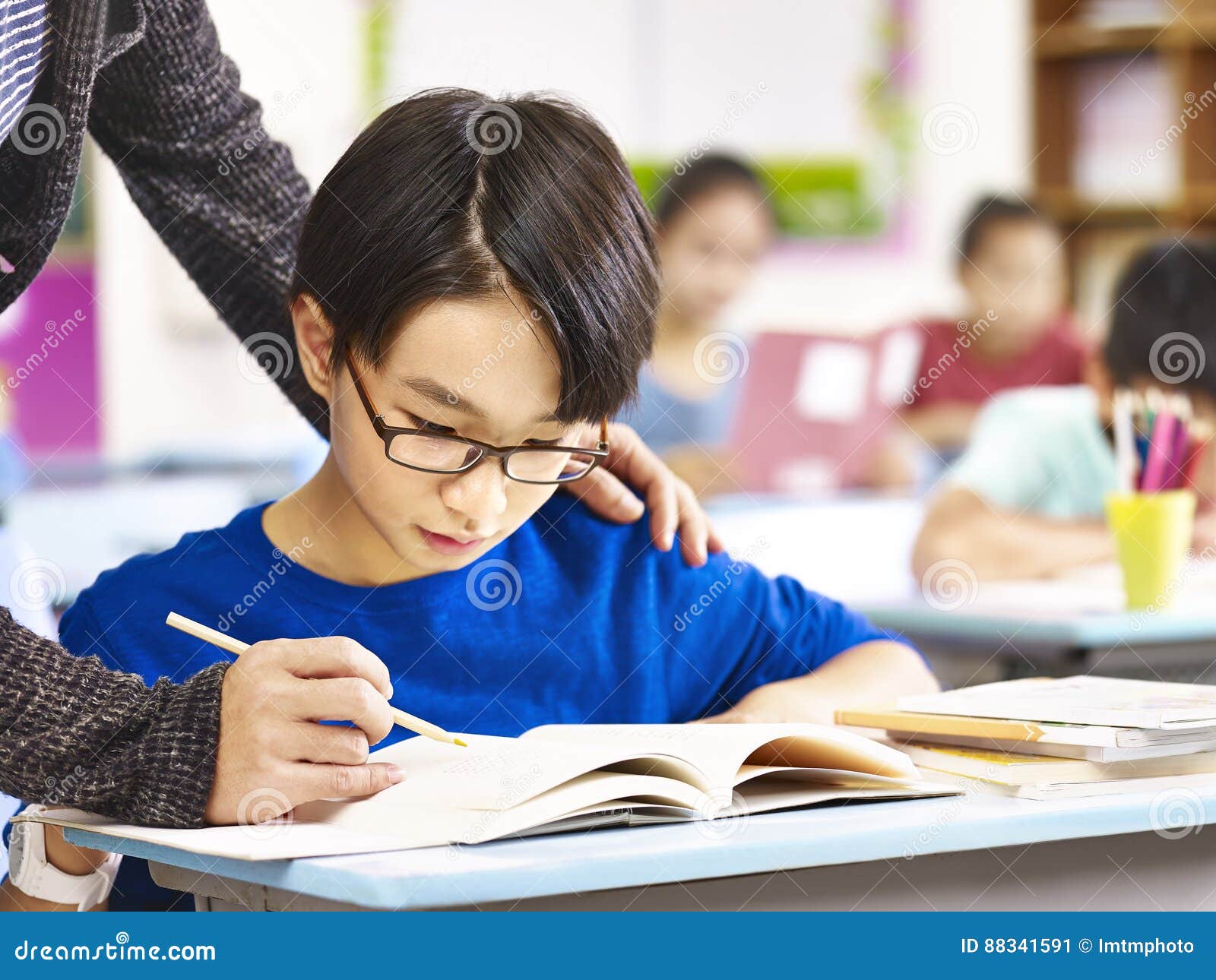 Asian Primary School Student Getting Help from Teacher Stock Image ...