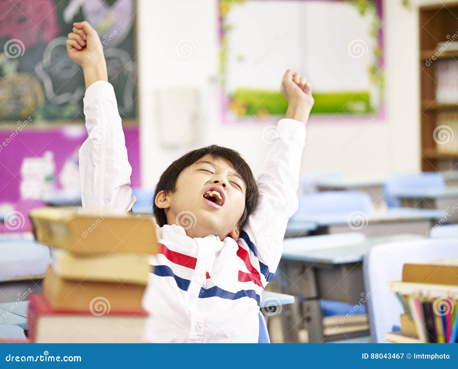 Asian Primary School Student Stretching in Classroom Stock Image ...