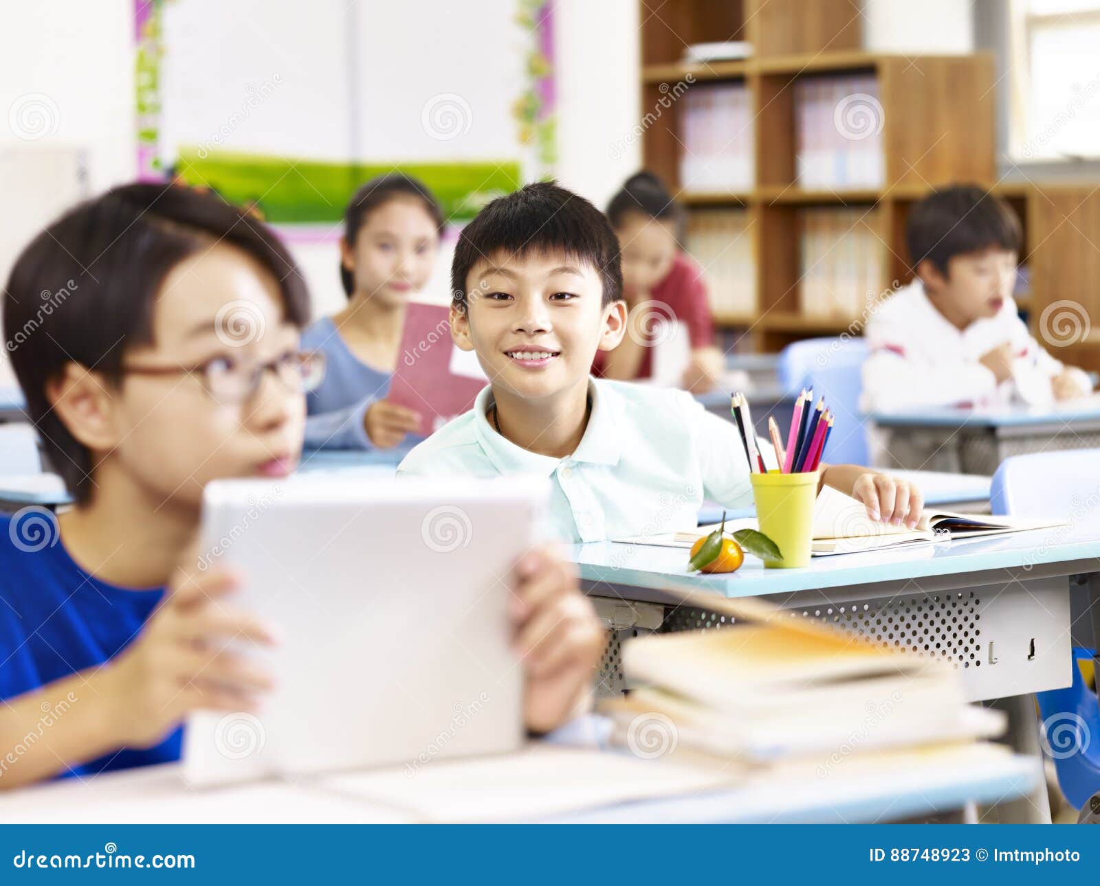 Asian Primary School Student Using Tablet In Classroom Stock Image ...
