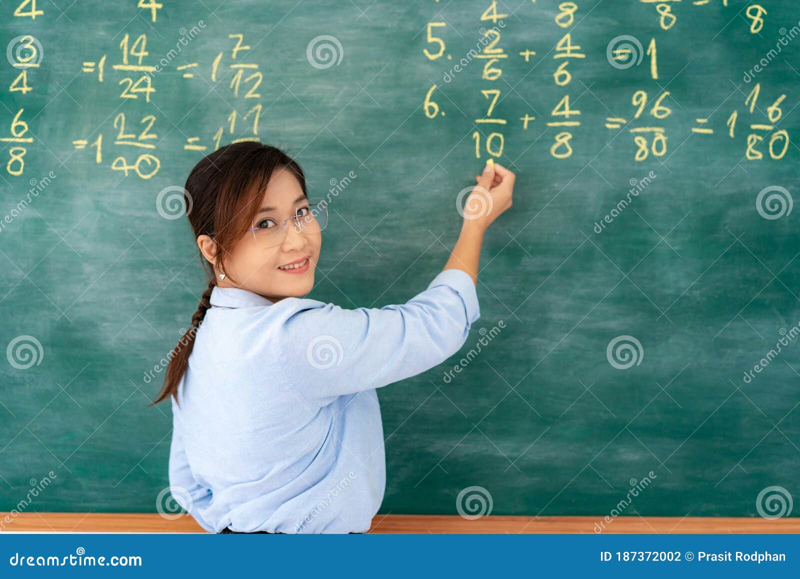 Asian Primary Teacher Tutor Explaining Math in Blackboard Giving Remote ...